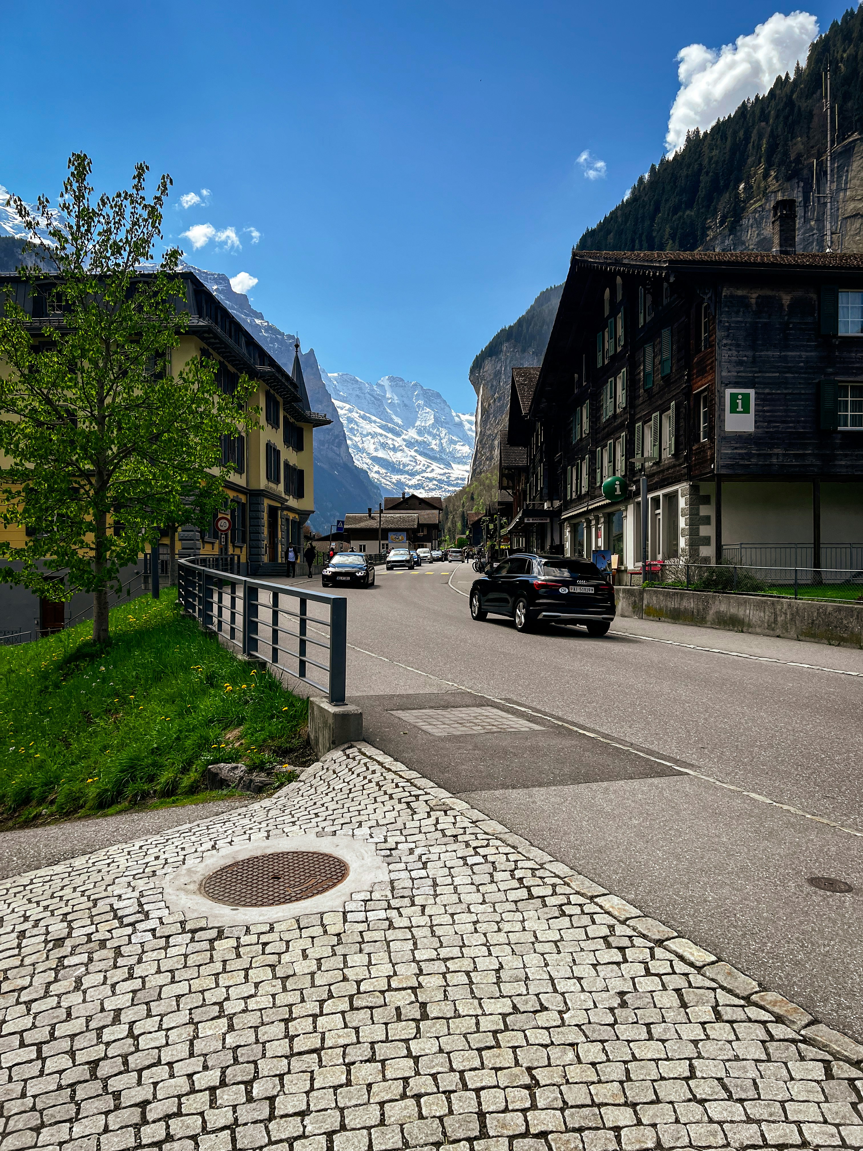 a street with cars and buildings on the side