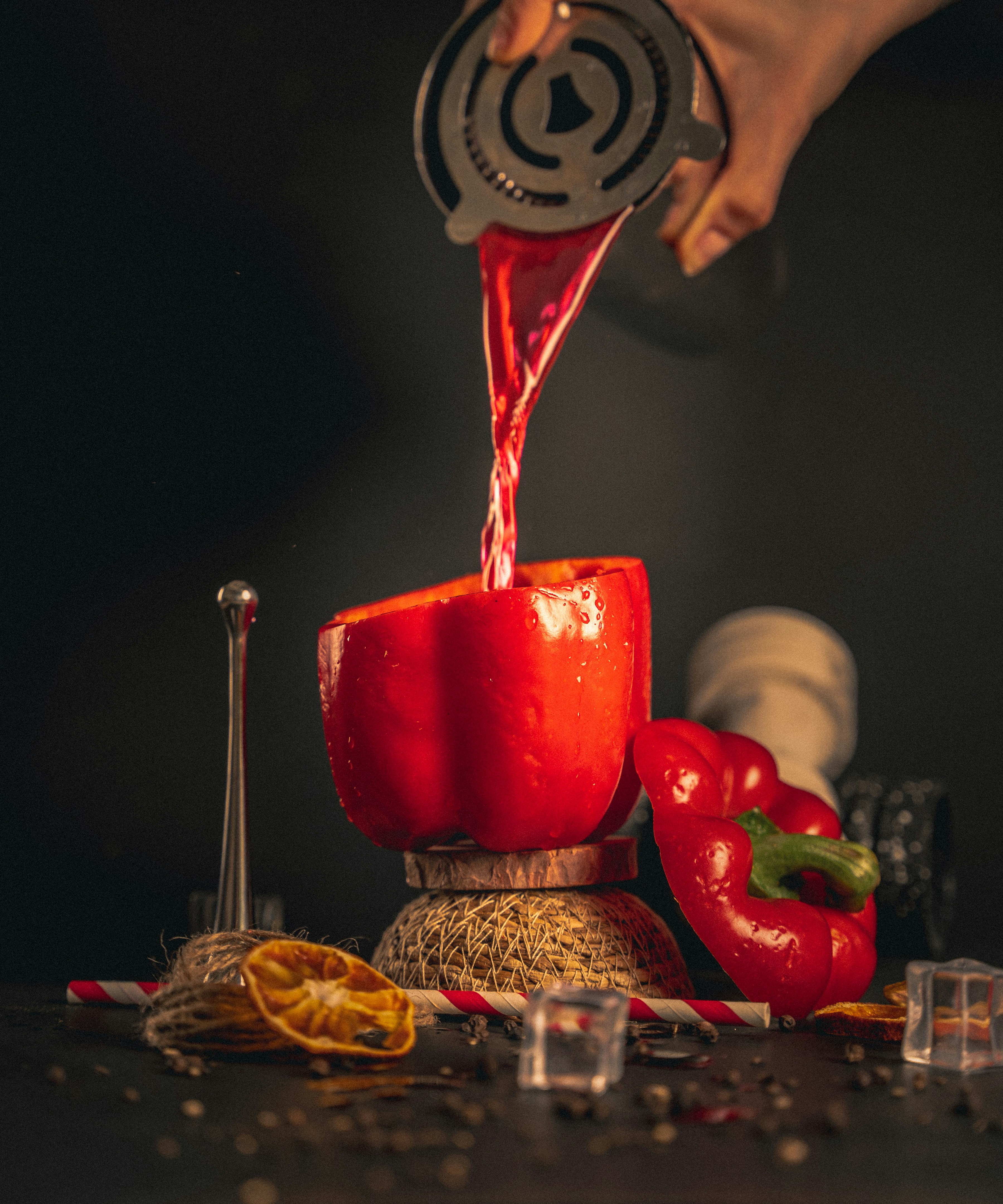 Crimson Cascade: Pouring Red into a Pepper on a Cork Pedestal