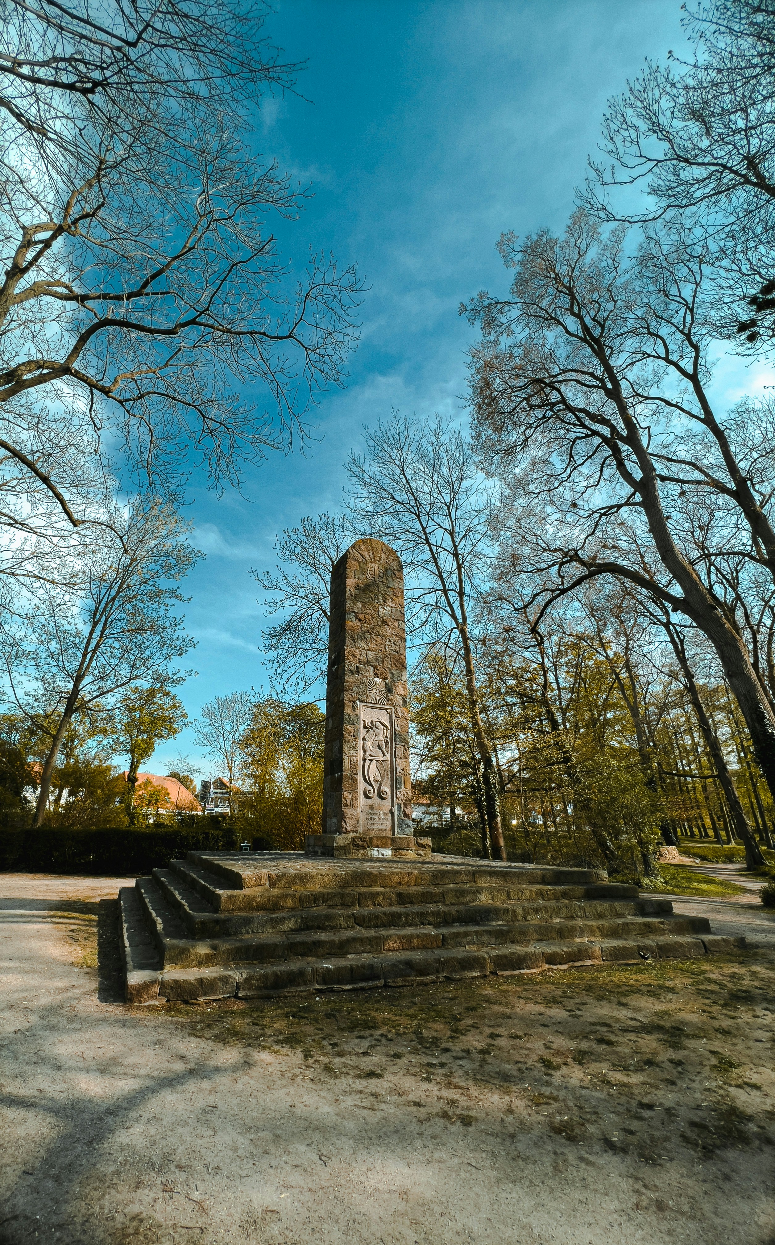 A stone monument with trees around it photo – Free Blue Image on Unsplash