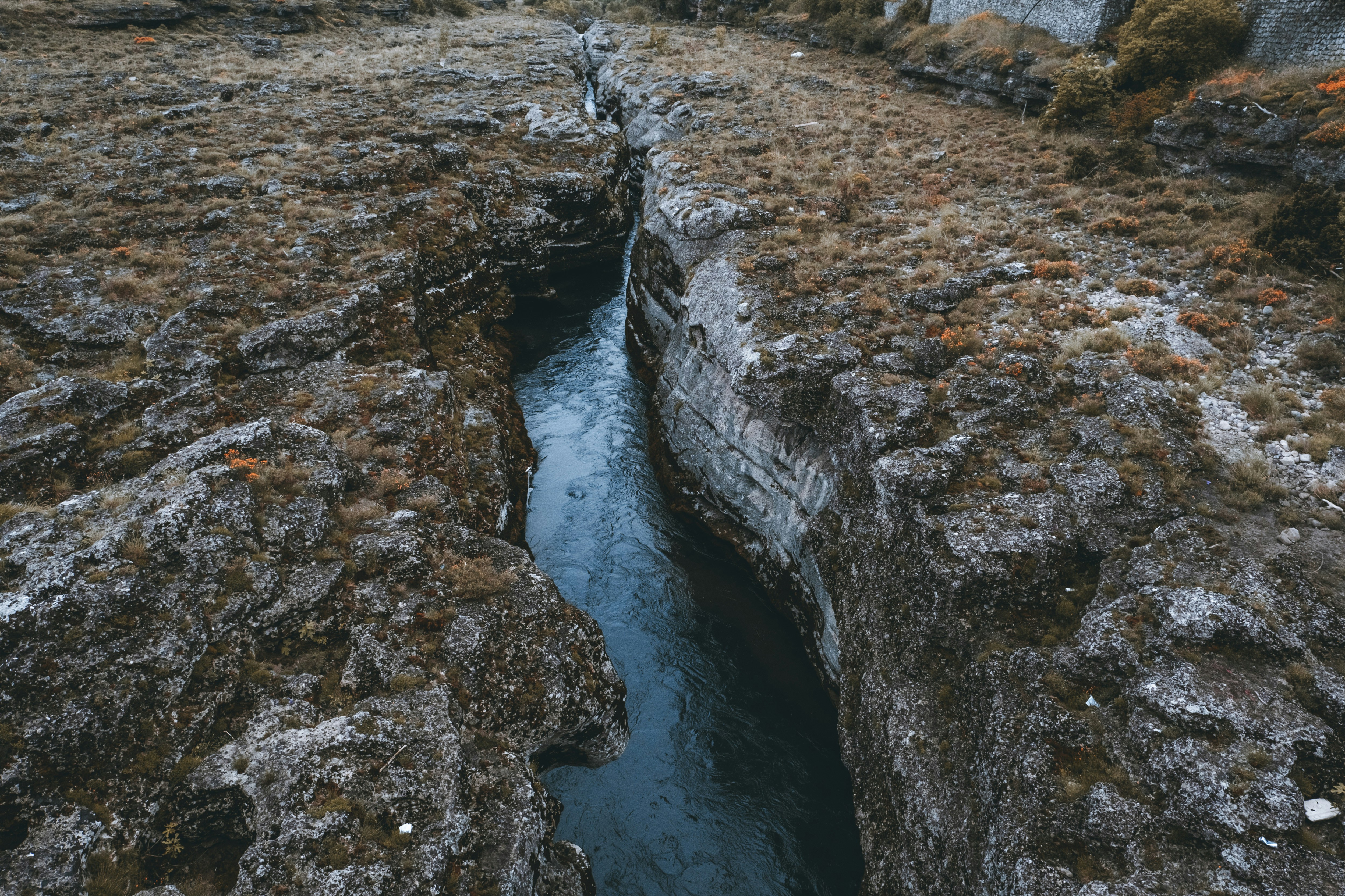 A stream of water flowing through rocks photo – Free Albania Image on ...