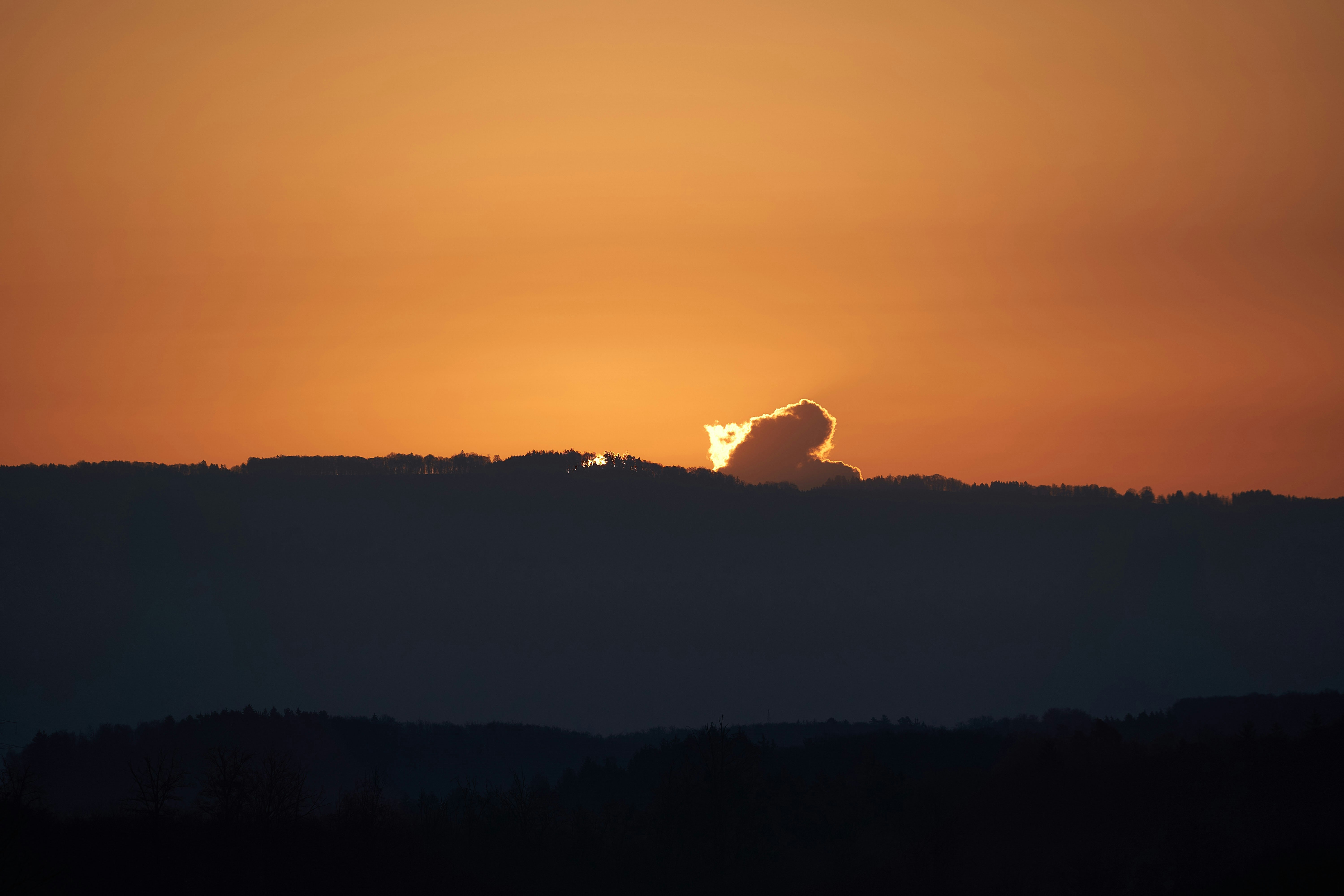 Ember on the Edge: A Dawn Cloud Framing the Quiet Horizon