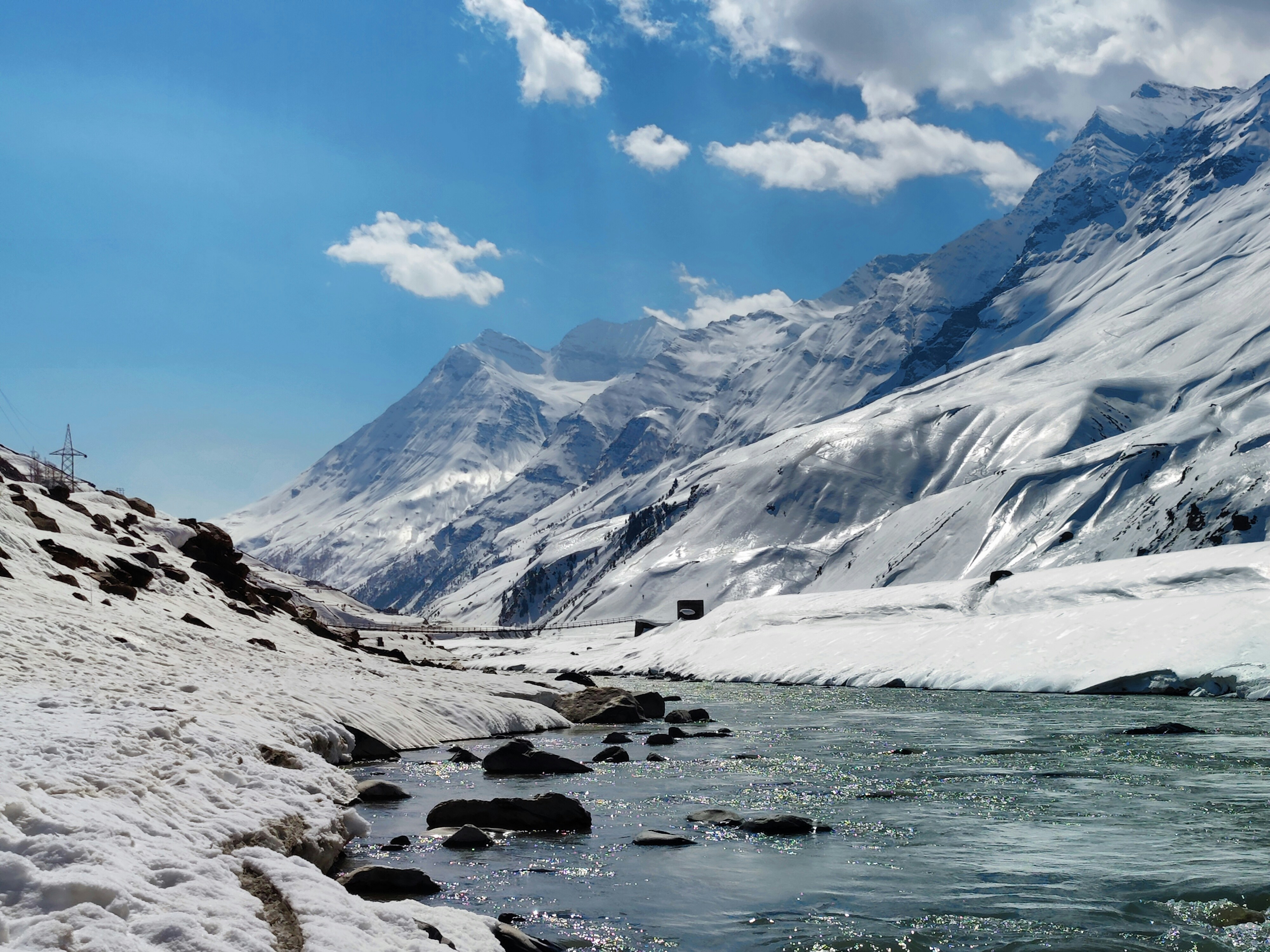 A body of water with a snowy mountain in the background photo – Free ...