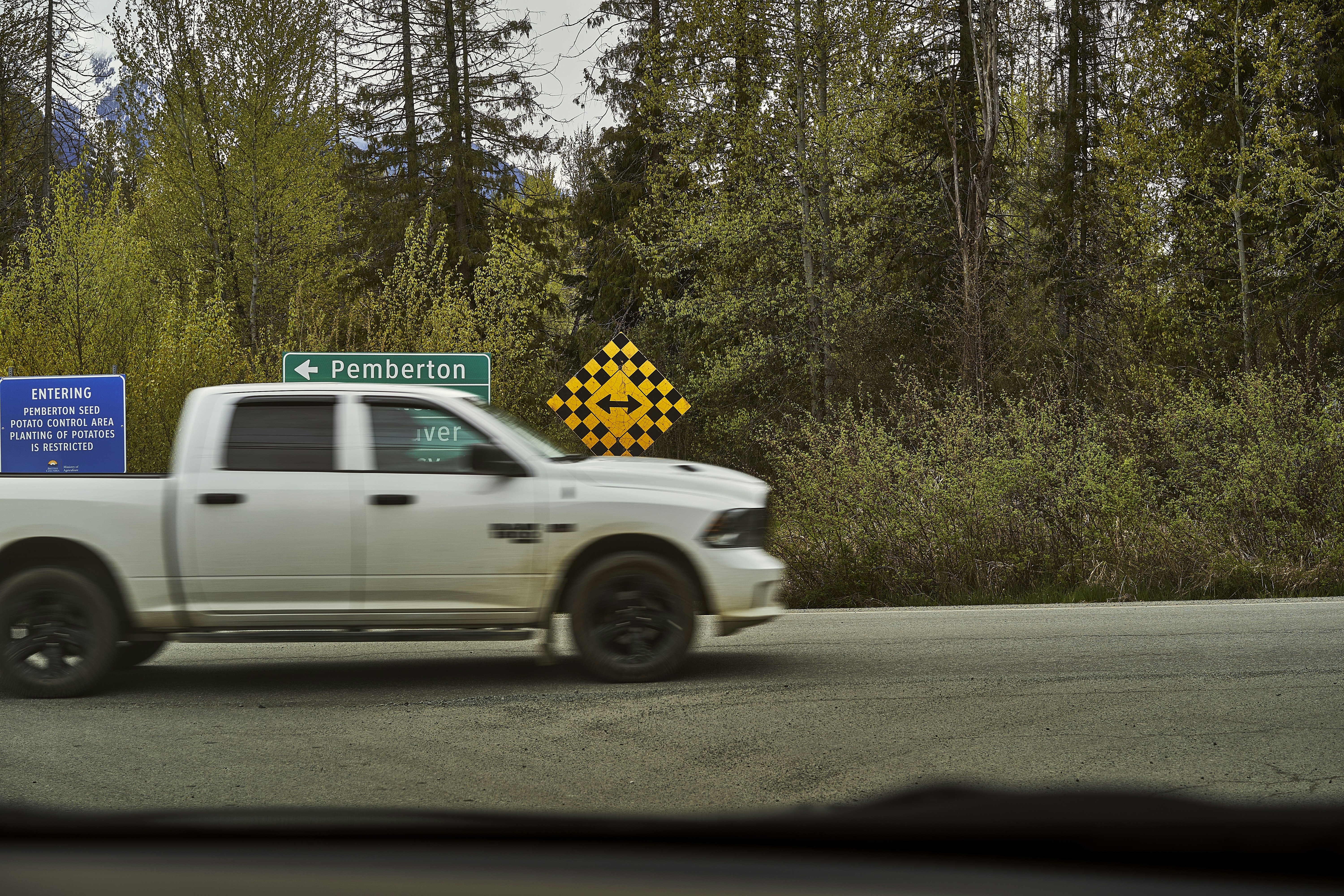 A white truck with a yellow sign on the back photo – Free Pickup truck ...