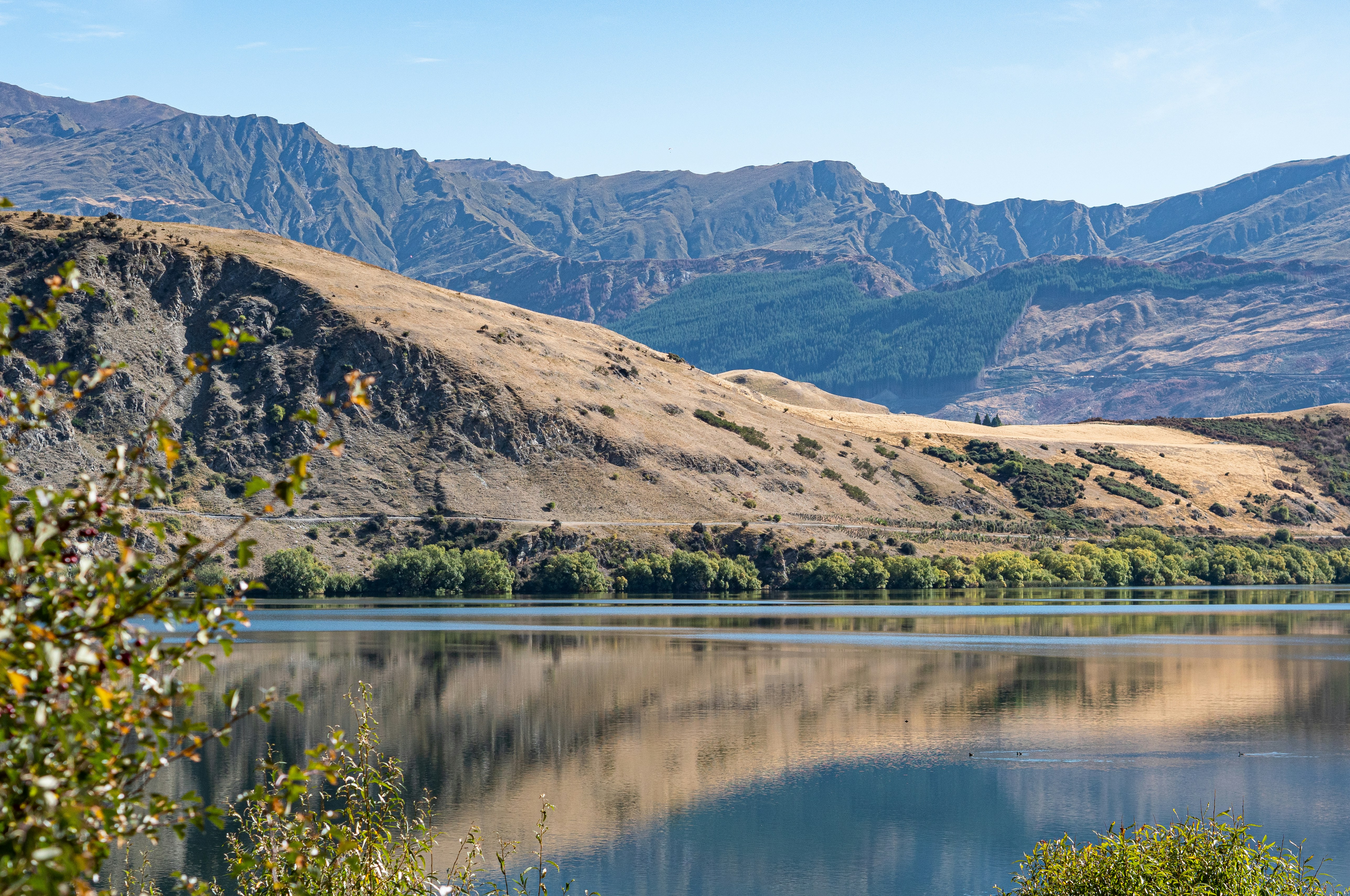 A lake with hills in the background photo – Free Lake hayes Image on ...