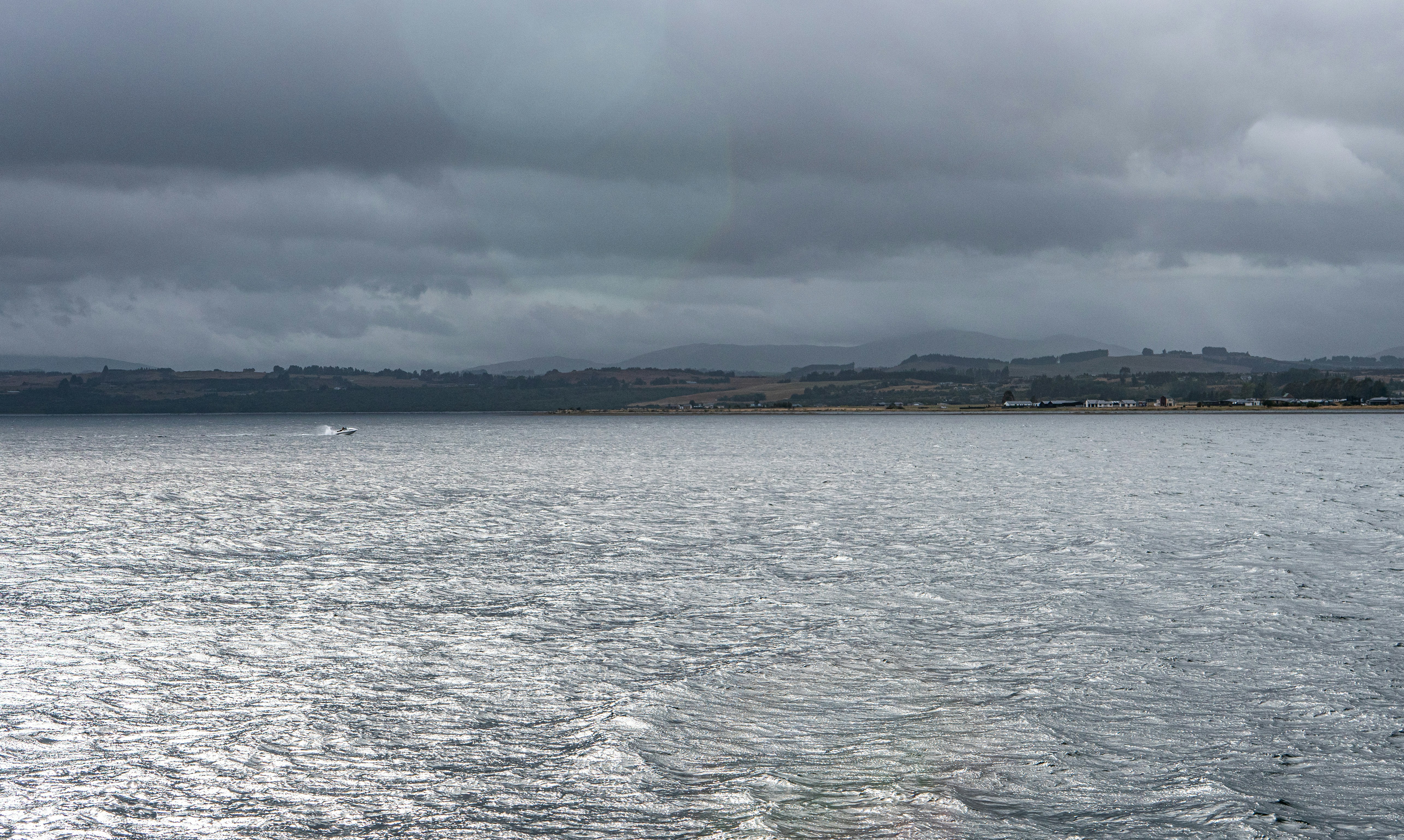 A body of water with a city in the distance photo – Free Grey Image on ...
