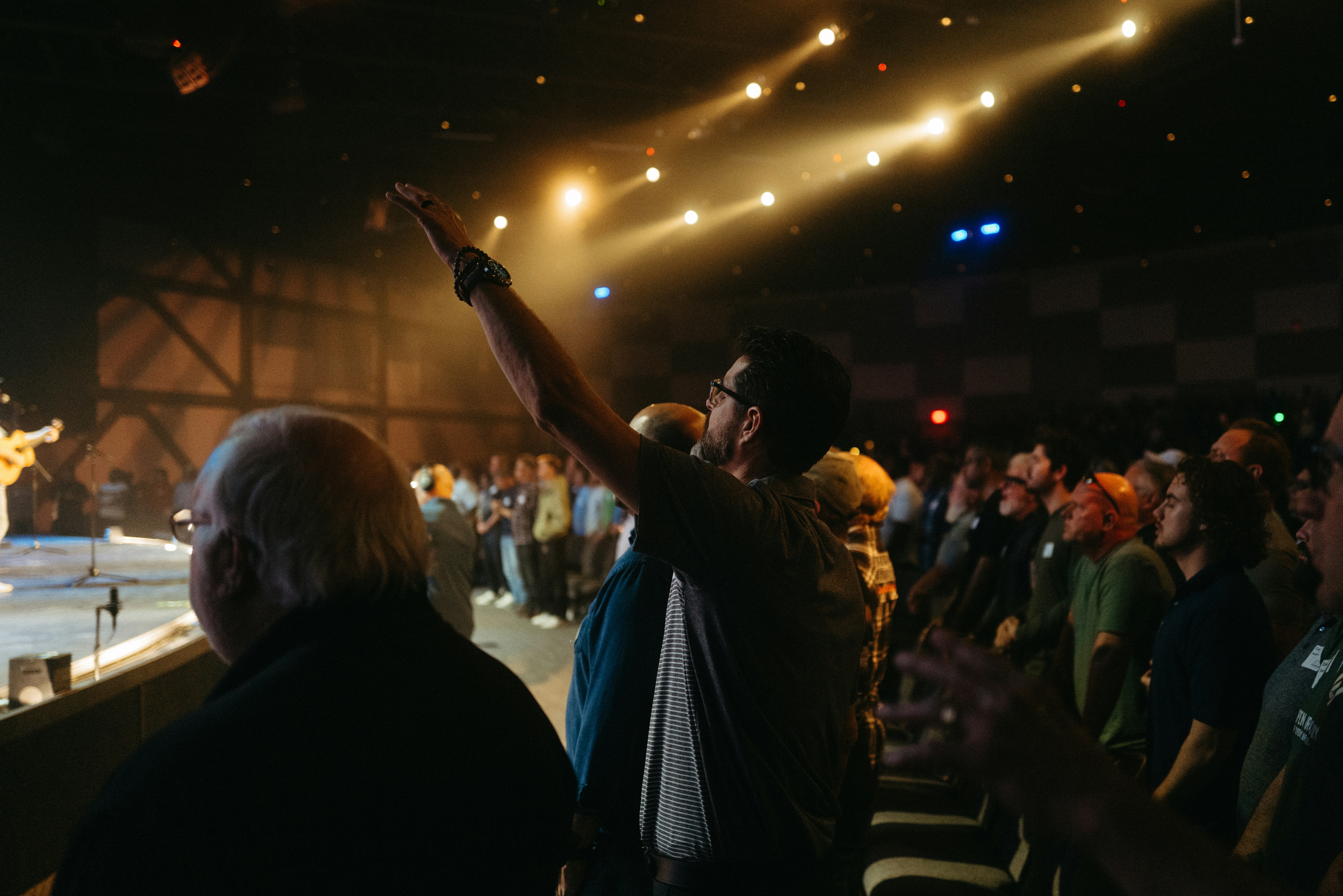 Audience engaged in a lively performance, showcasing a moment of connection and enthusiasm. The scene captures the energy of a live event.