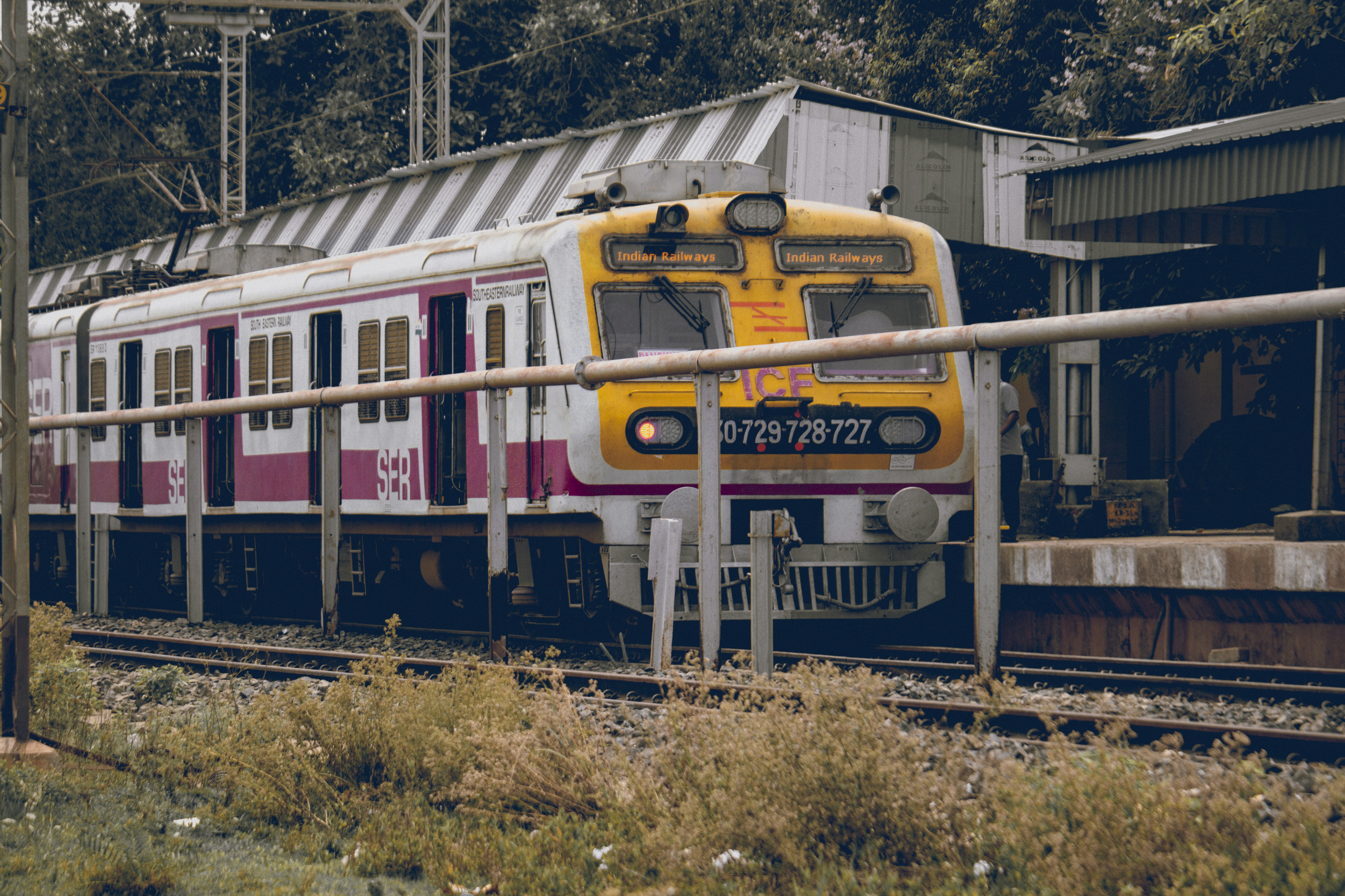Train on the platform waiting for passengers, showcasing urban transportation dynamics.