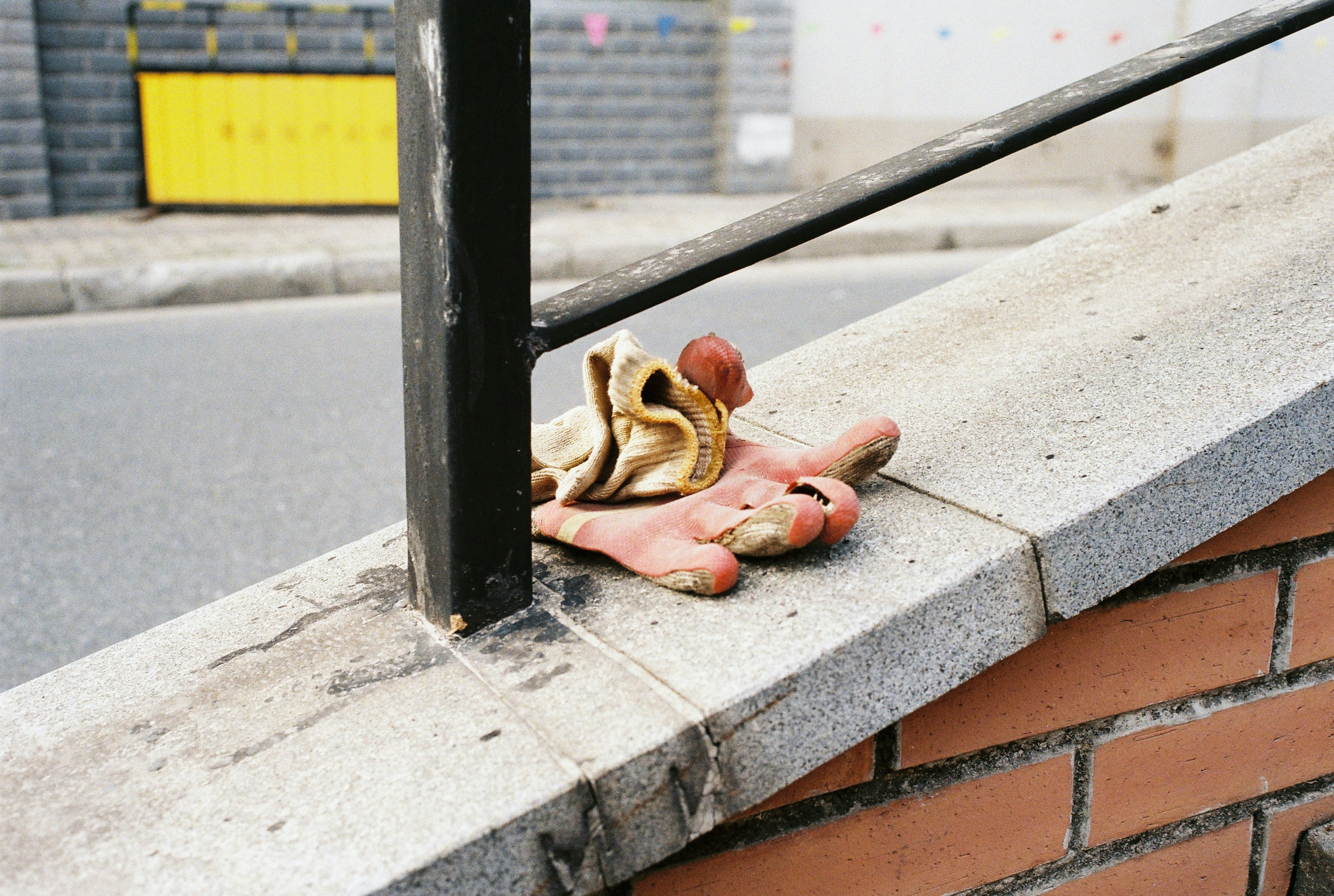 Edge of the City: The Pink Glove on a Concrete Ledge