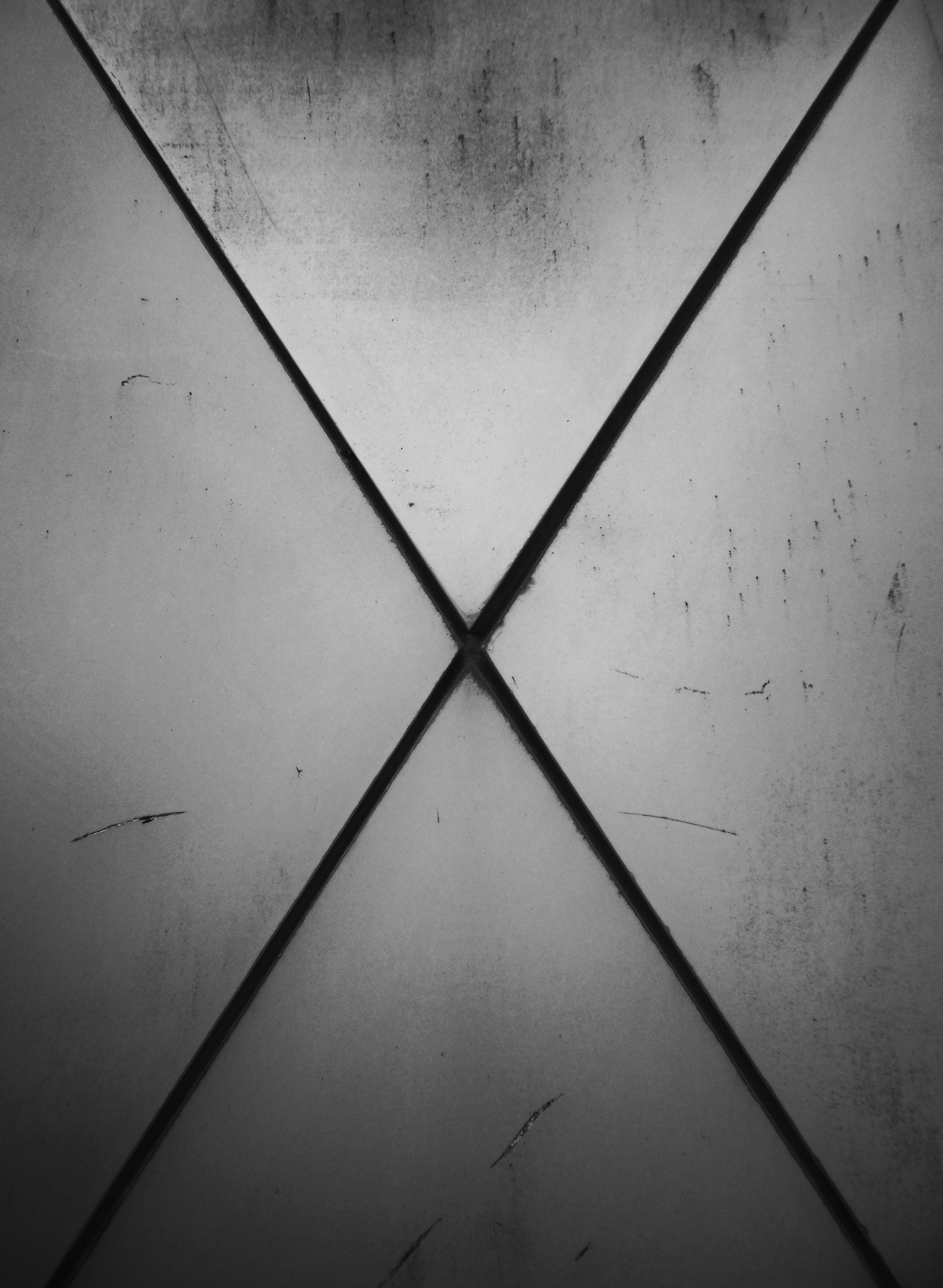 Convergence at Center: An X of Scratched Metal