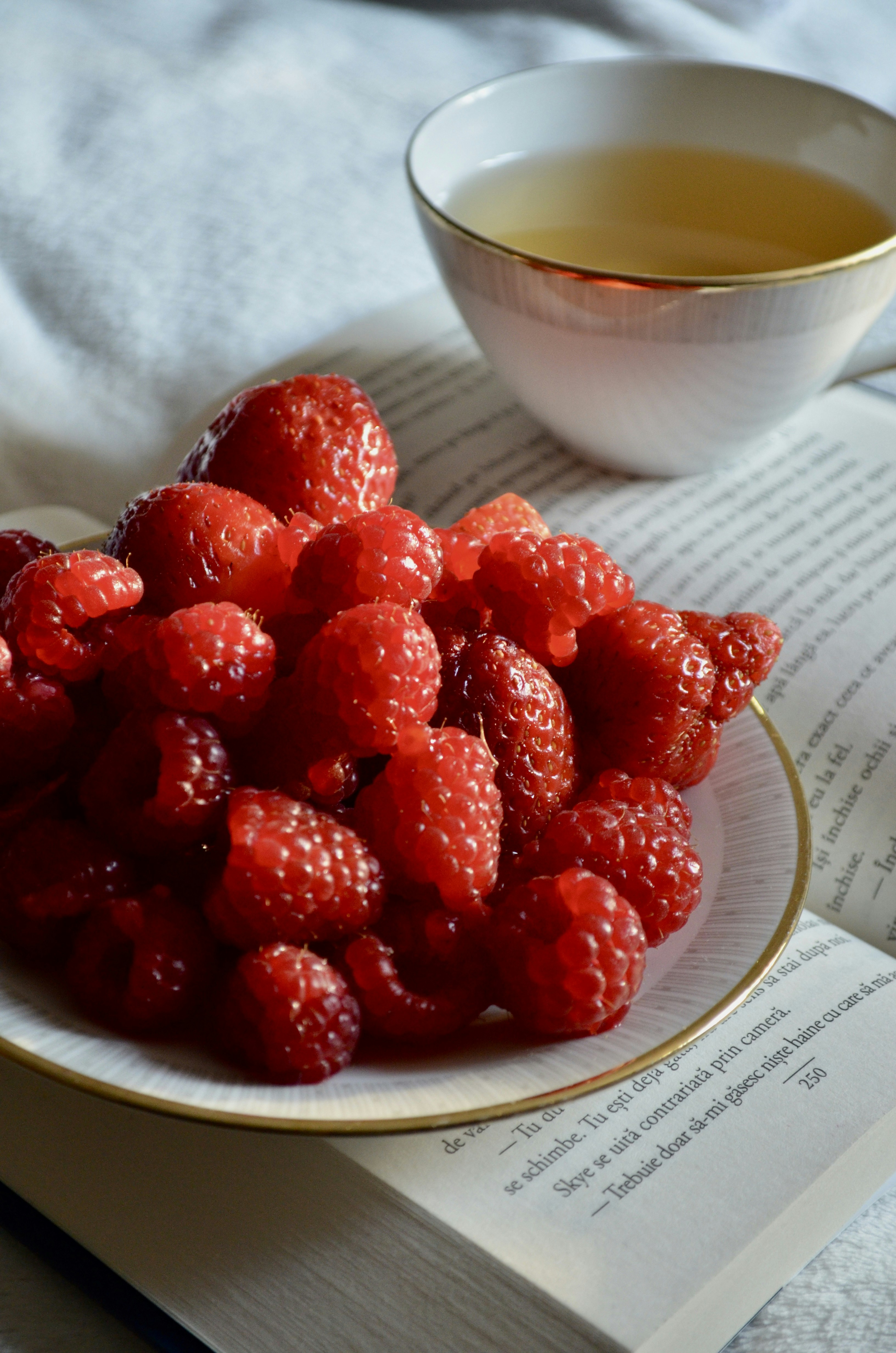 Scarlet Raspberries on a Quiet Page: A Teacup Still-Life