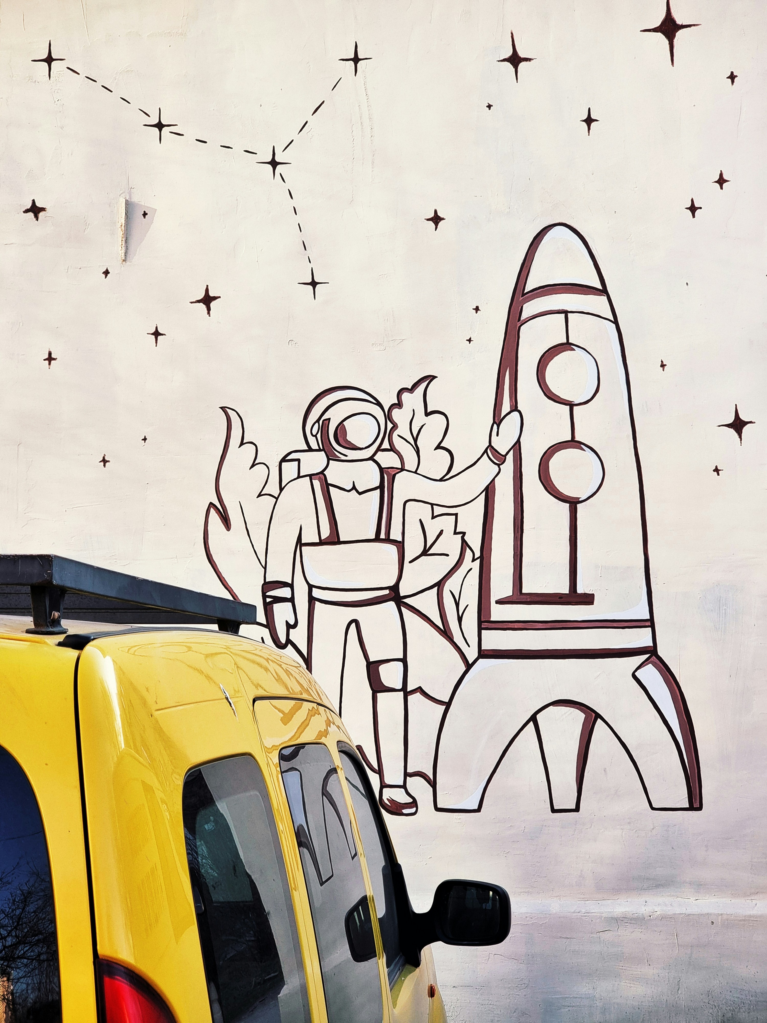 Star Wardens on the Wall: Astronaut, Rocket, and a Neon Yellow Van