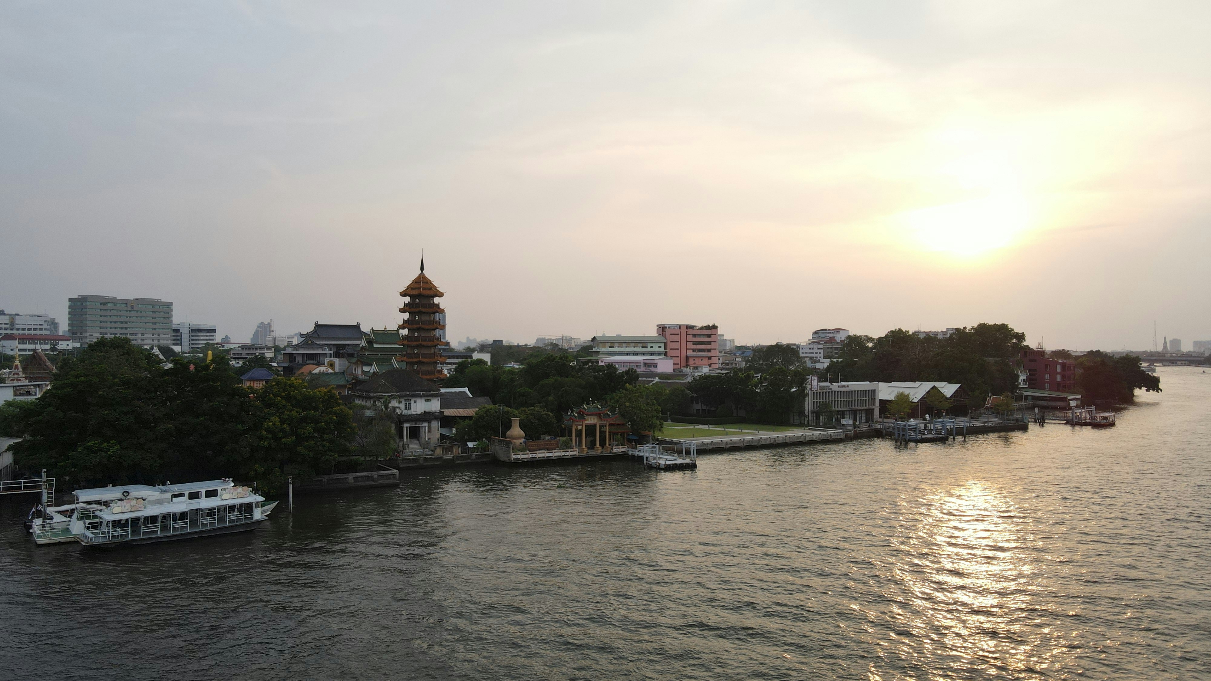Evening Pagoda by the River: A Quiet Sunset Over a Traditional Skyline