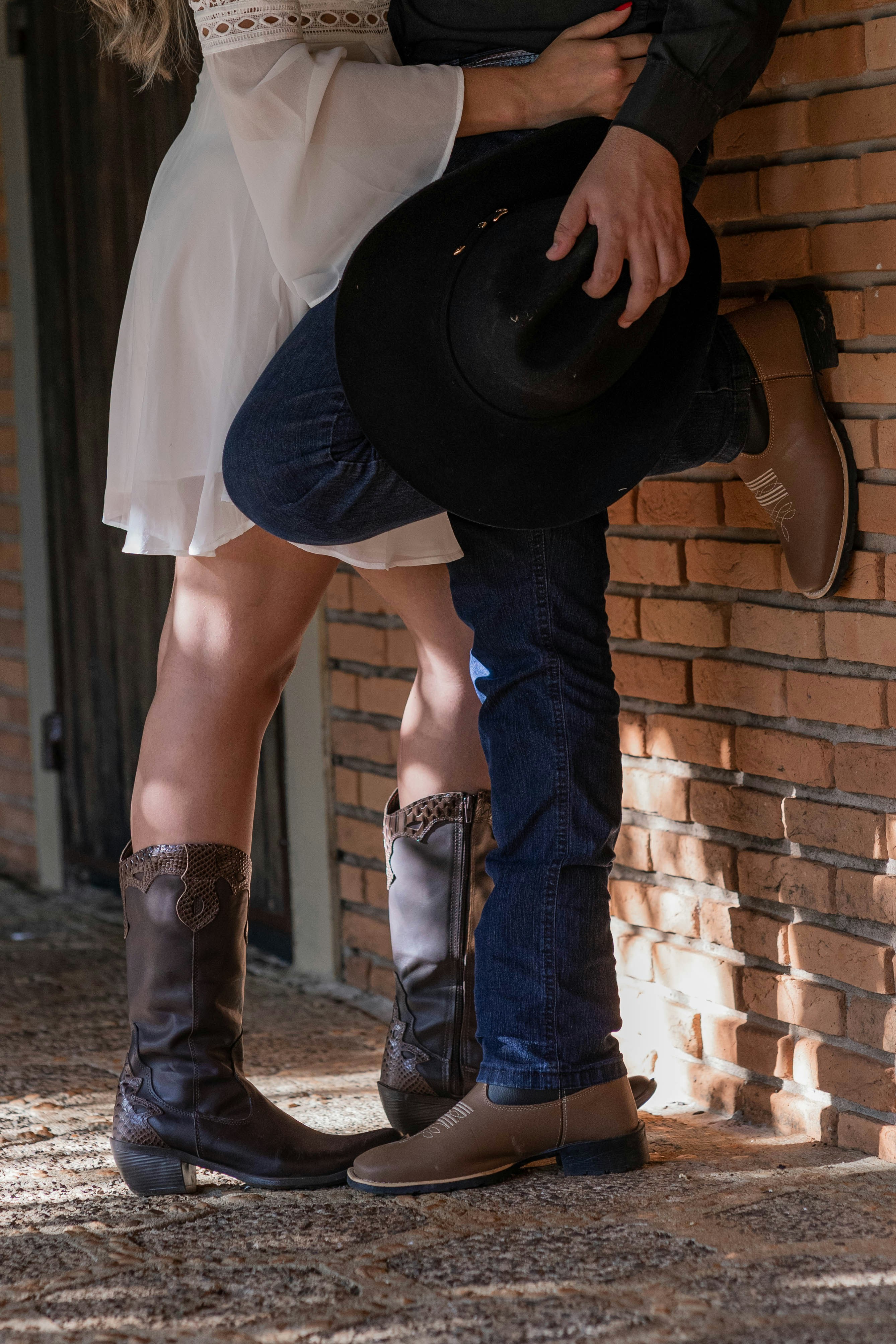 Hushed Steps and Shared Moment Against a Brick Wall
