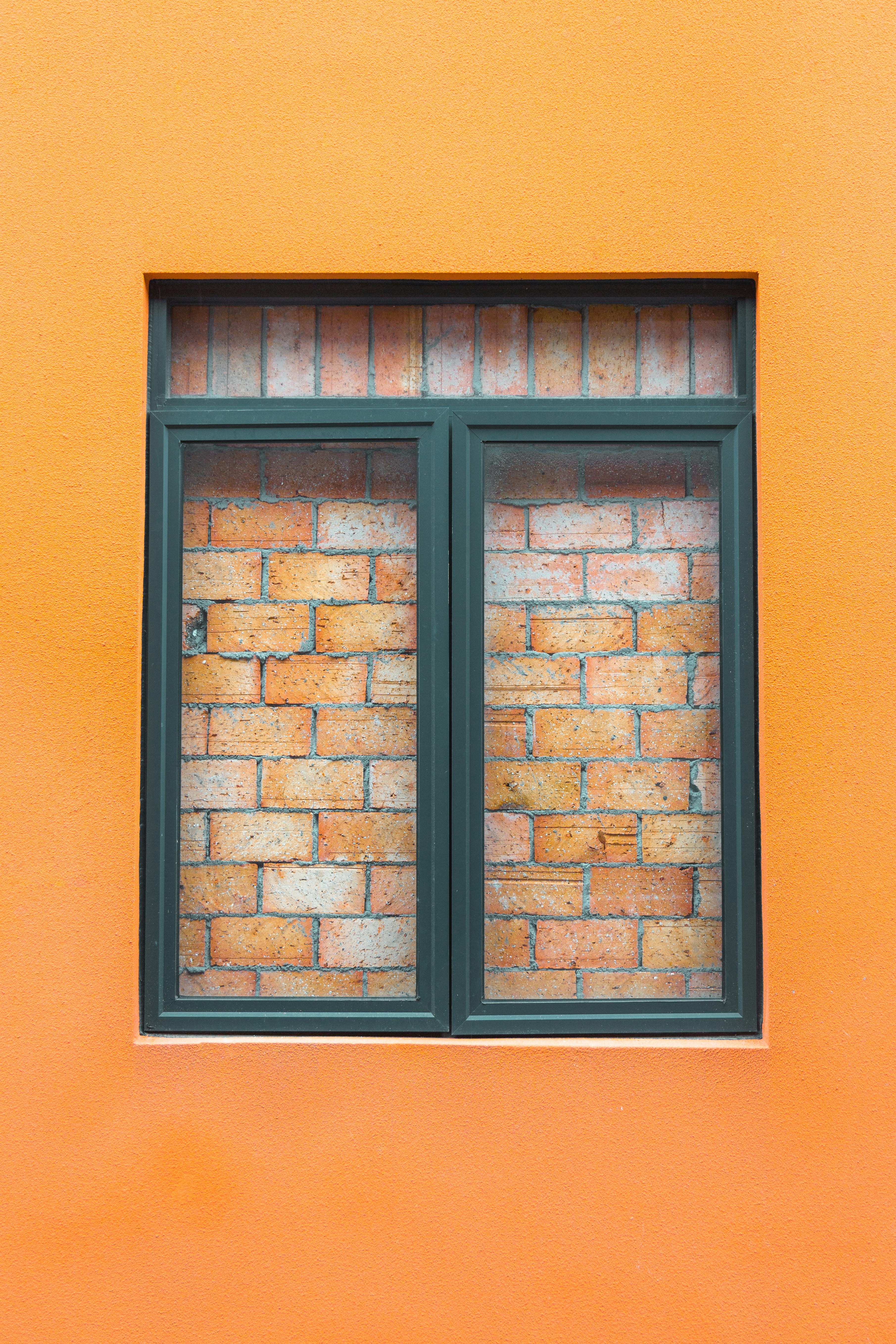 Emerald-Framed Window in a Tangerine Wall
