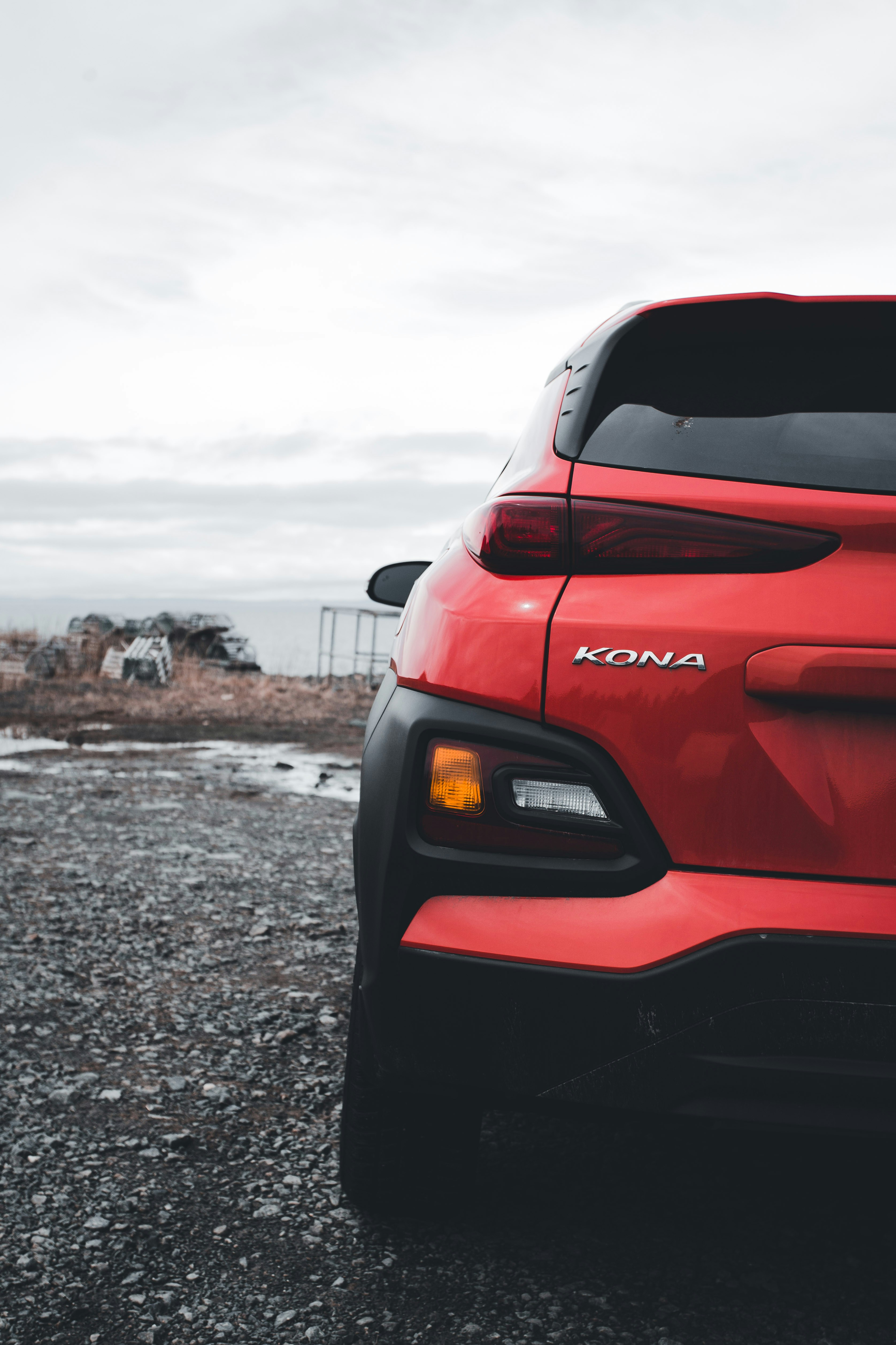 Red Hyundai Kona's Bold Rump of Light by a Quiet Shore