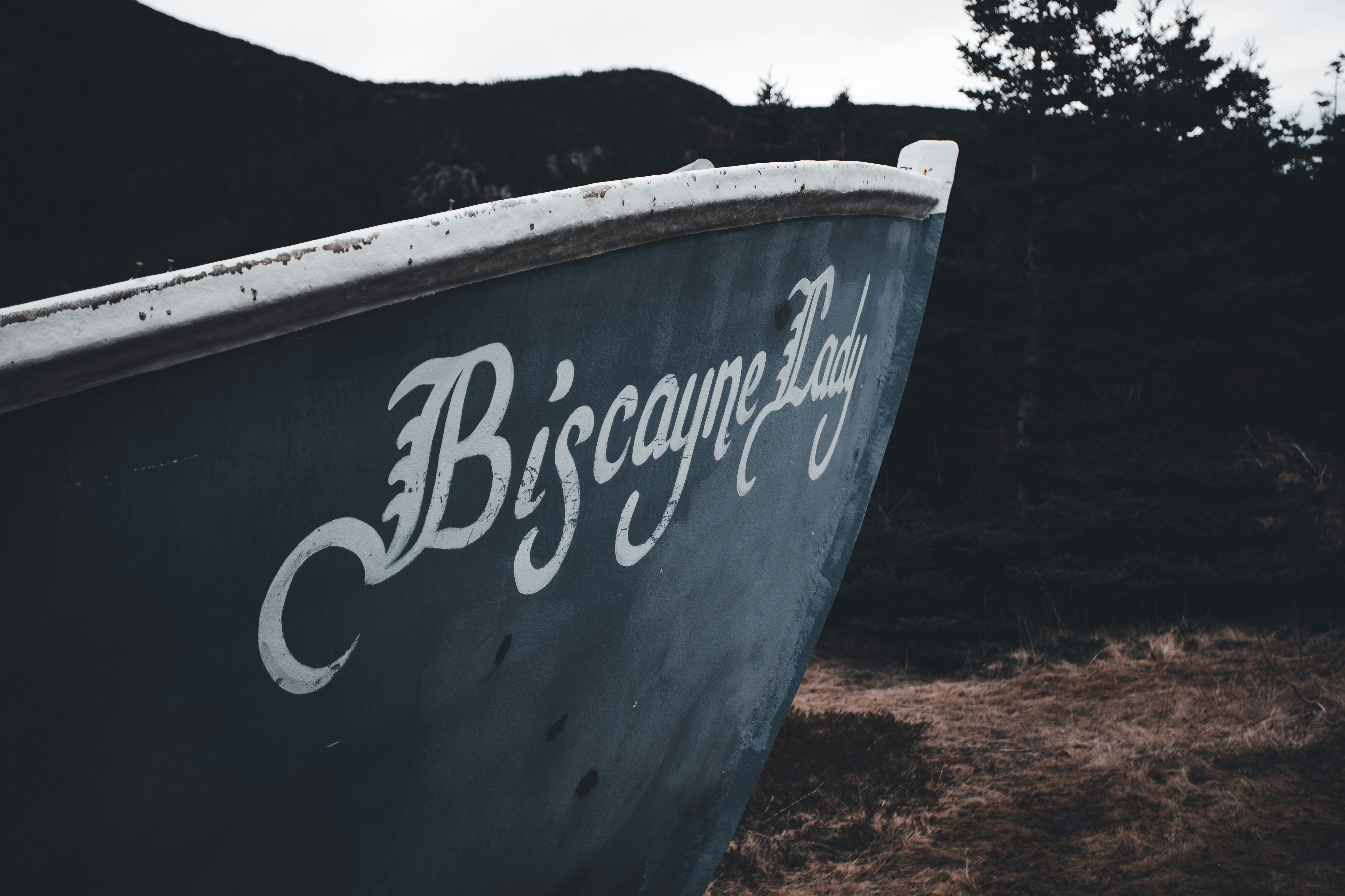 Weathered Boat Named Bisque Bay Resting at Dusk