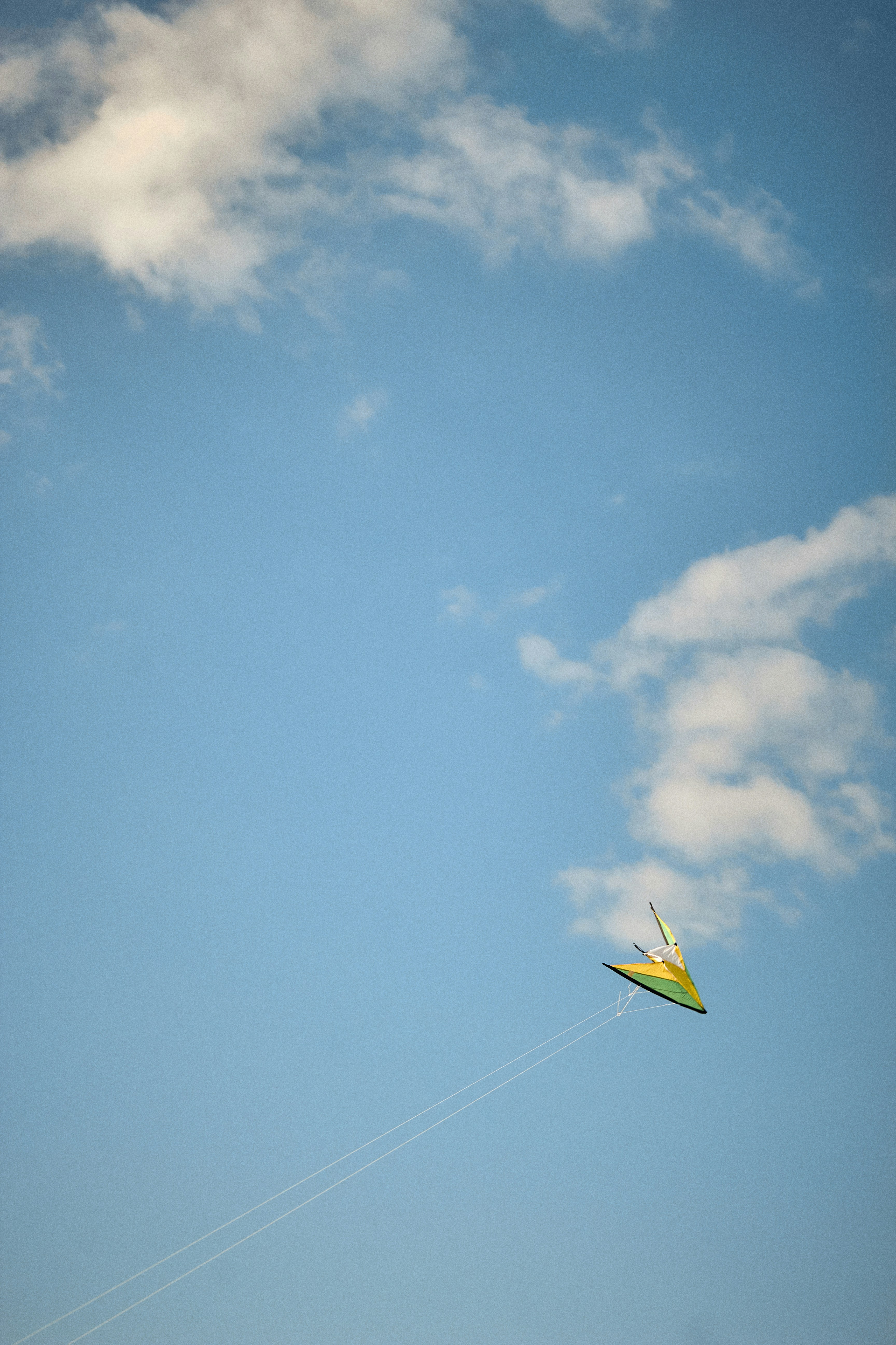 a yellow plane flying in the sky