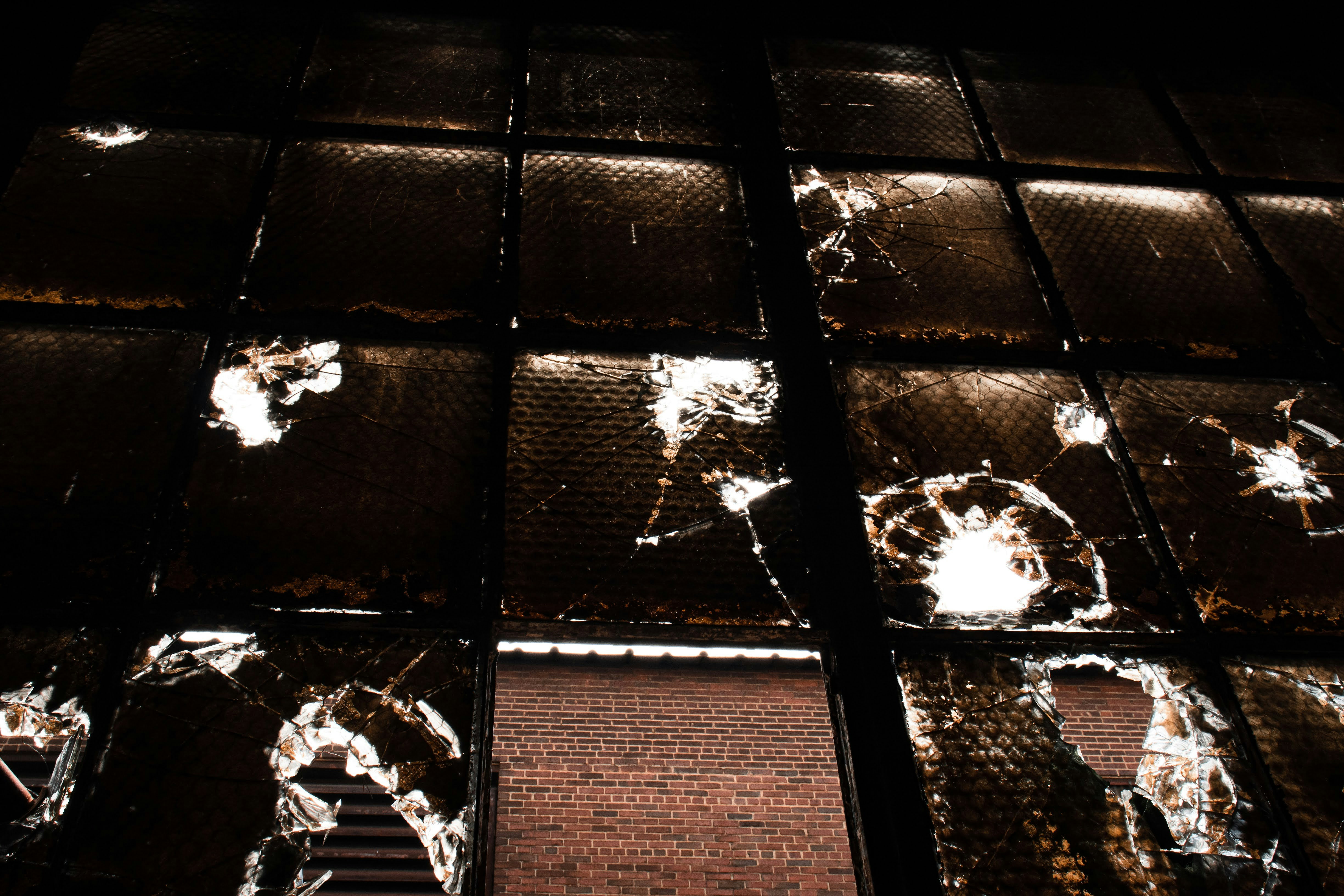 Night Grid: Frosted Panes Framing a Brick Accent
