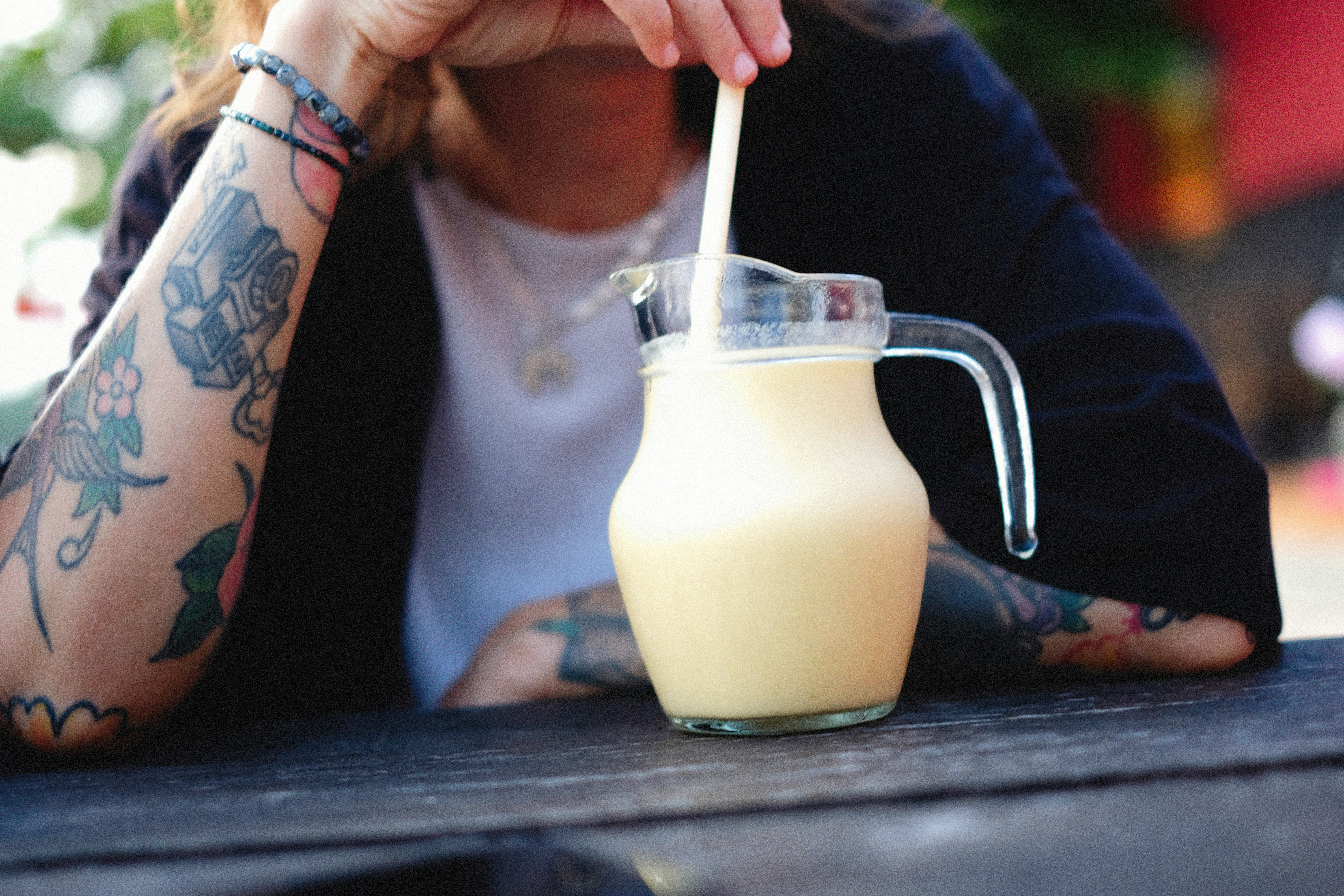a person holding a glass with a drink in it