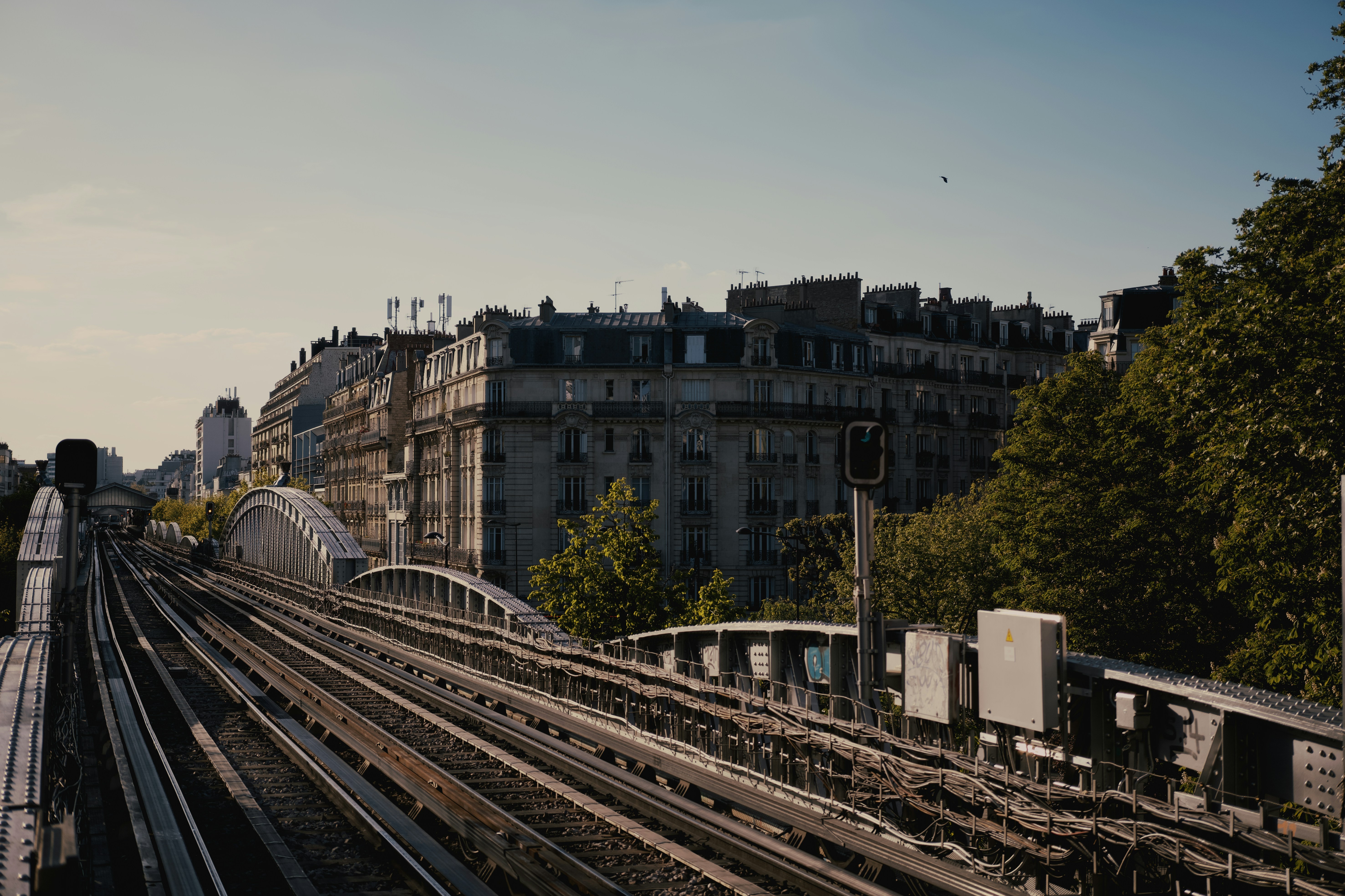 Dawn Over the Arched Rails: A Parisian Streetscape Framed by Steel