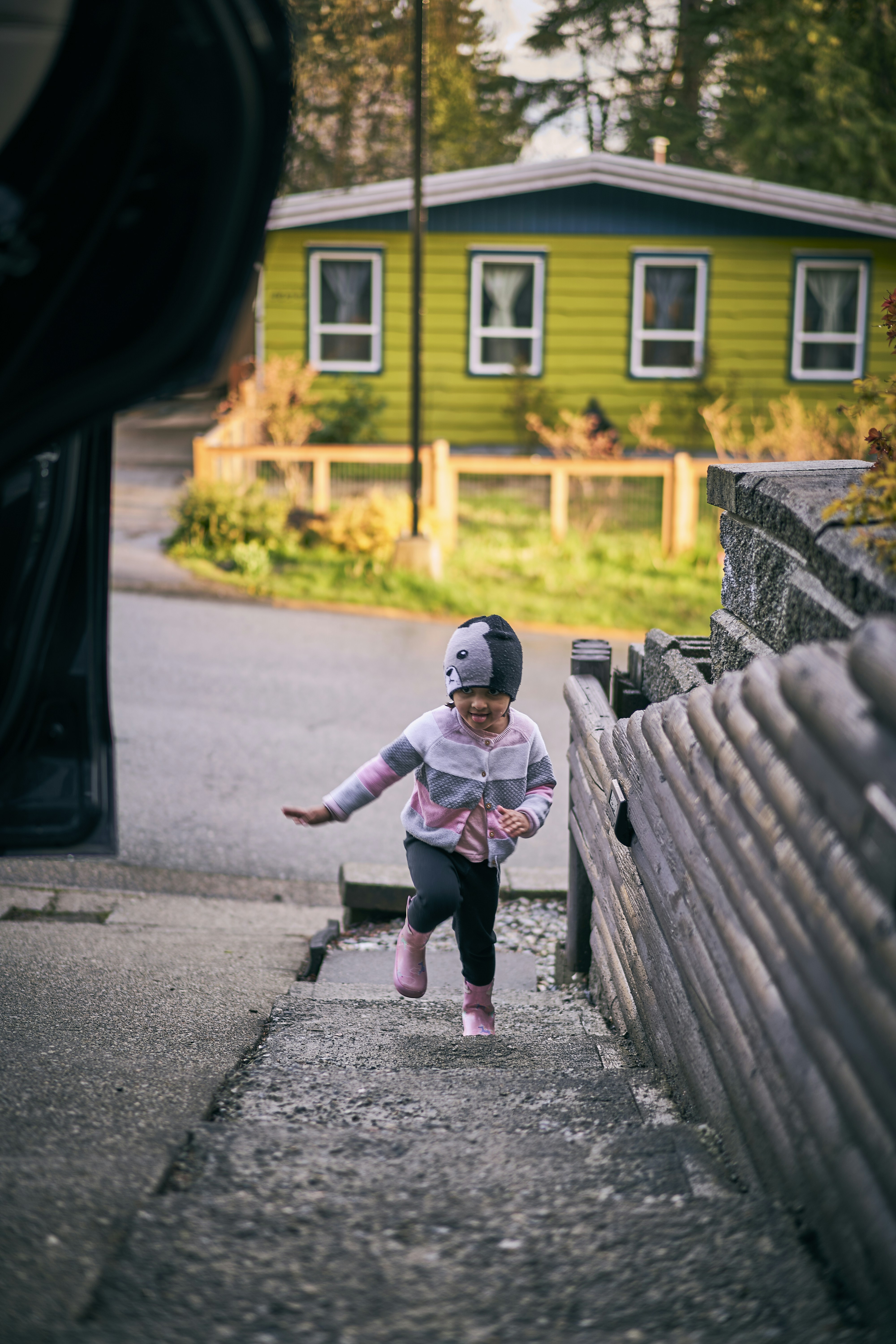 Suburban Sprint: A toddler's playful dash along a sunlit curb