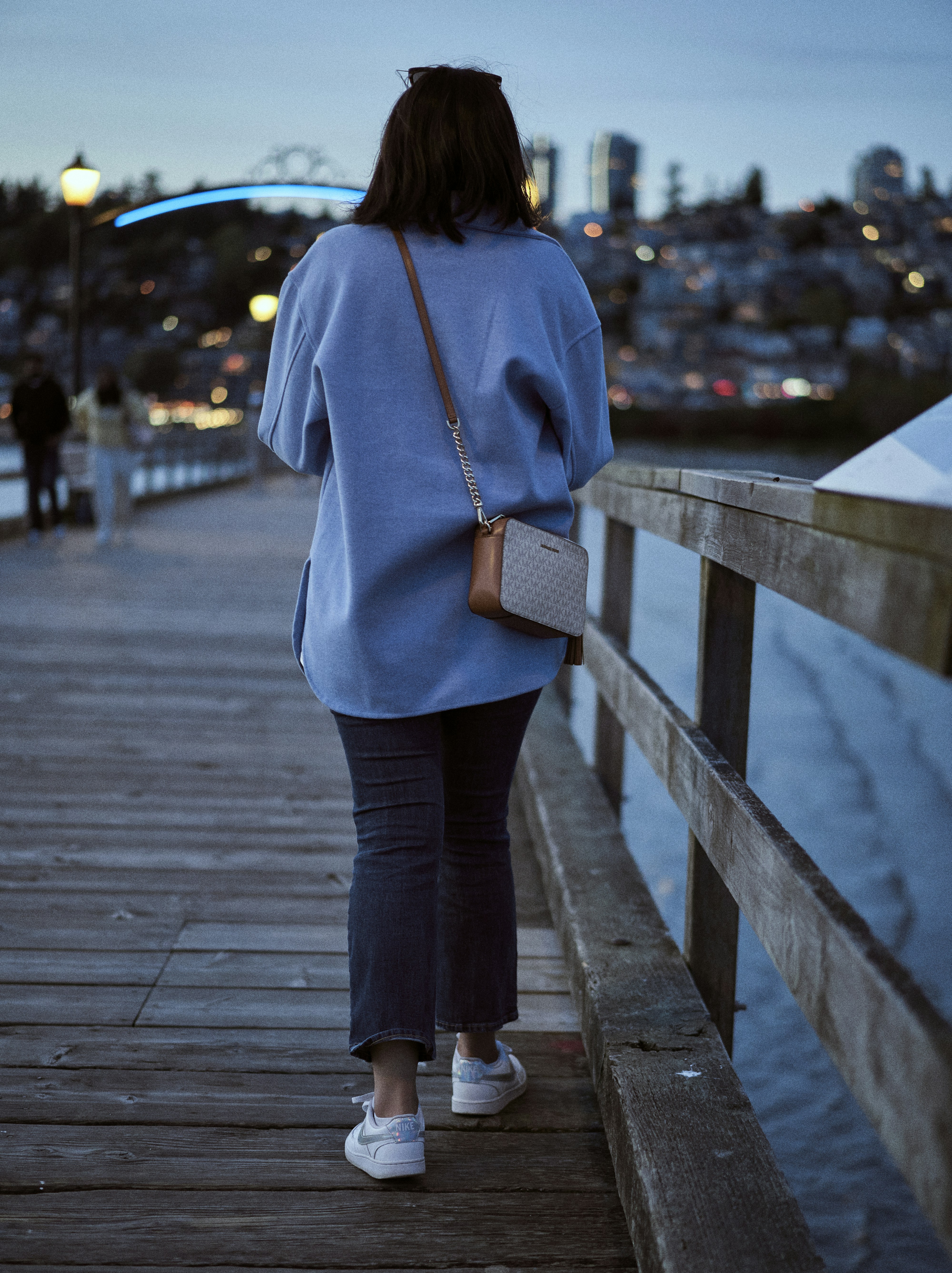 a woman standing on a bridge