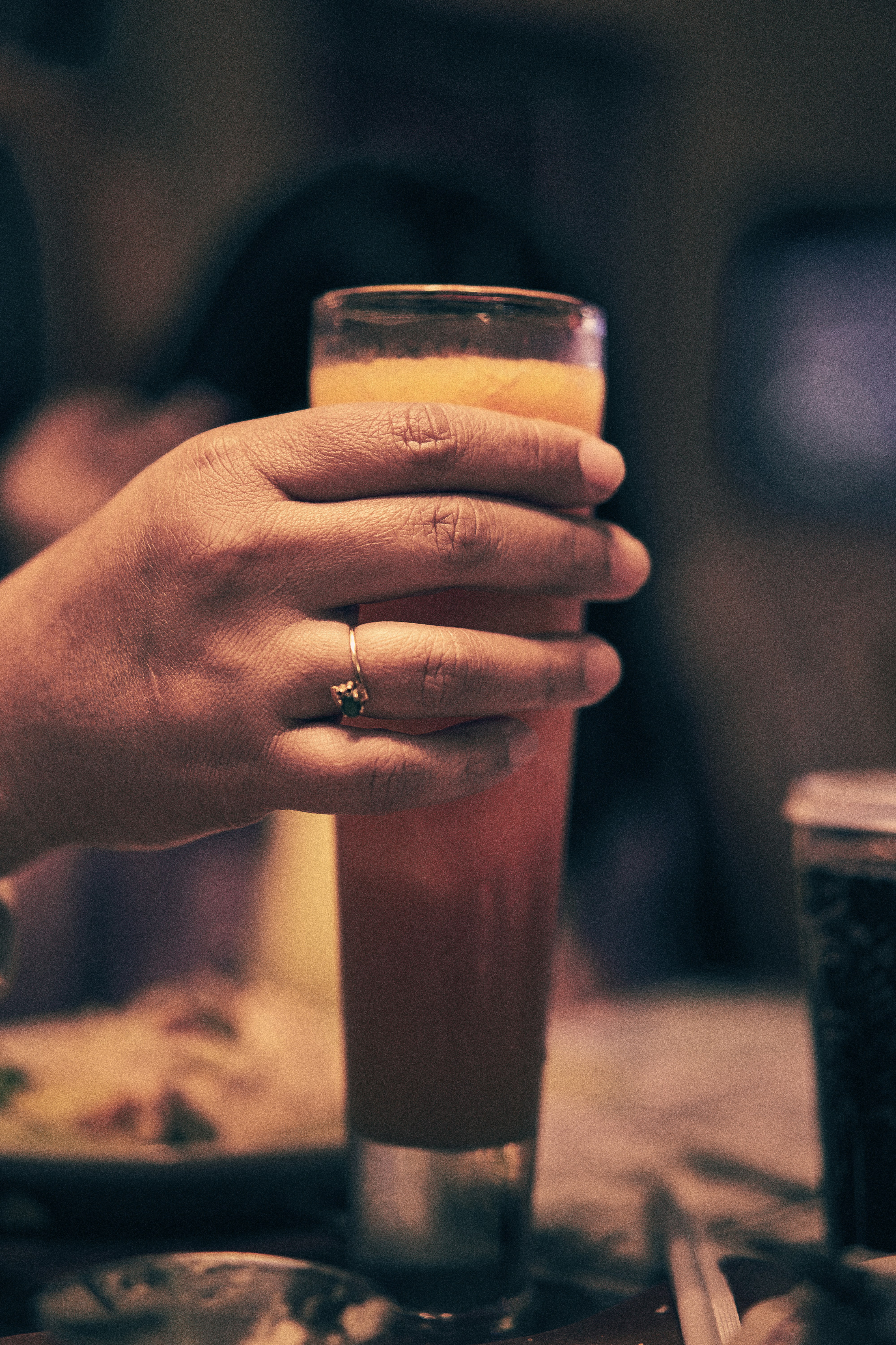 Amber Toast in Focus: A Hand, A Glass, A Quiet Moment