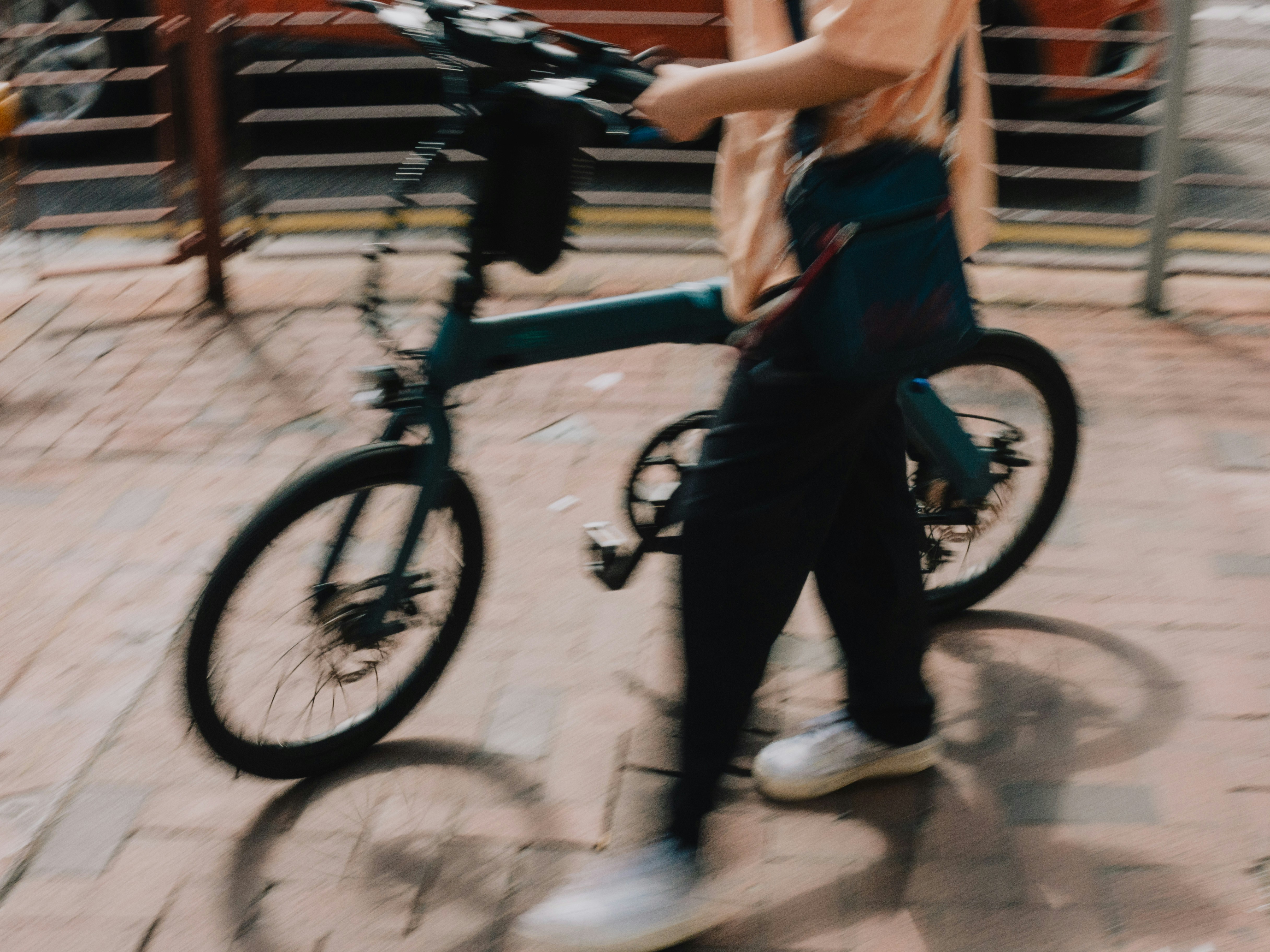 Motion Blur on Brick: A Pedestrian and Folding Bicycle in Transit