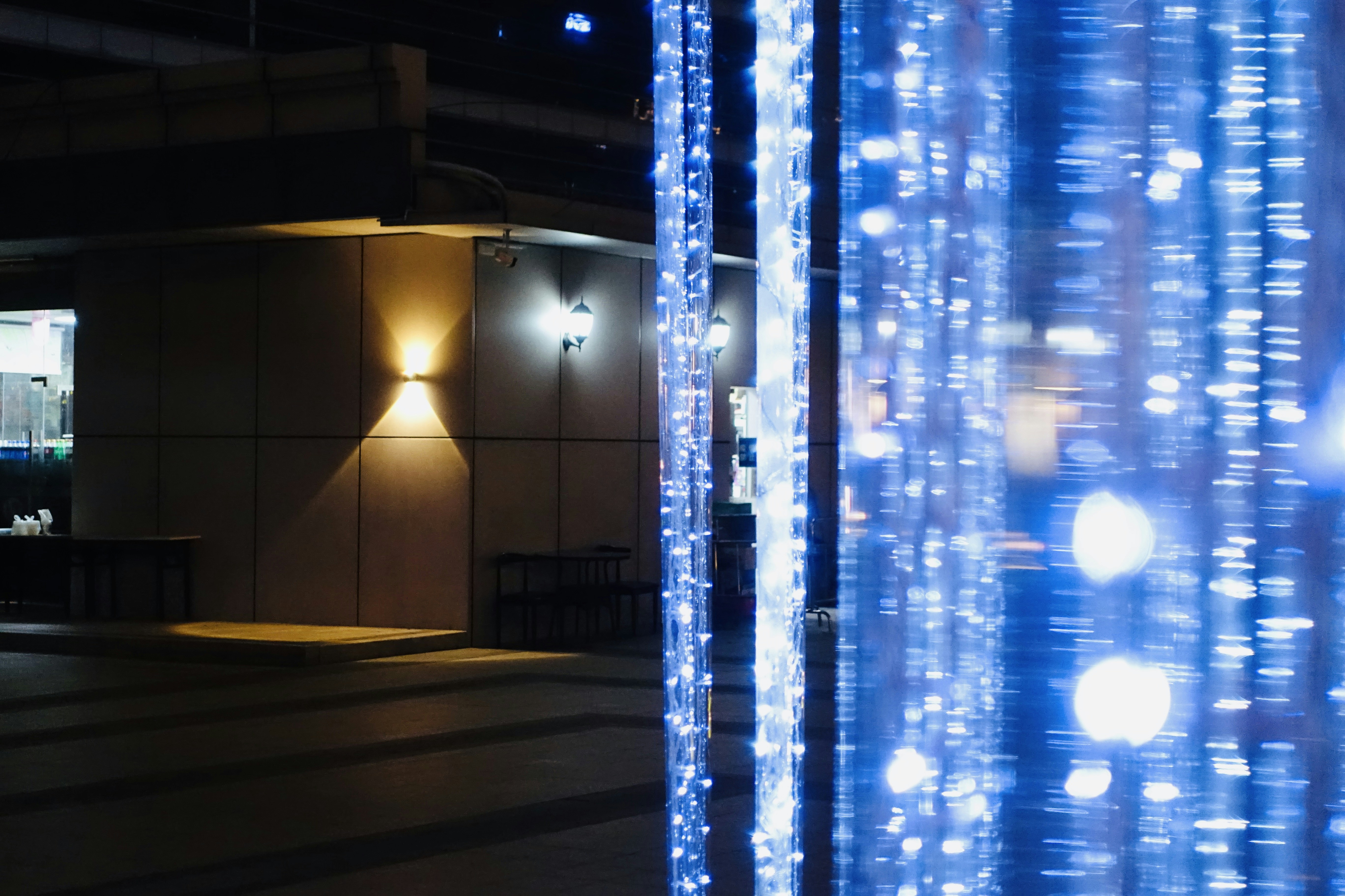 Blue Light Curtains at Quiet Night Courtyard