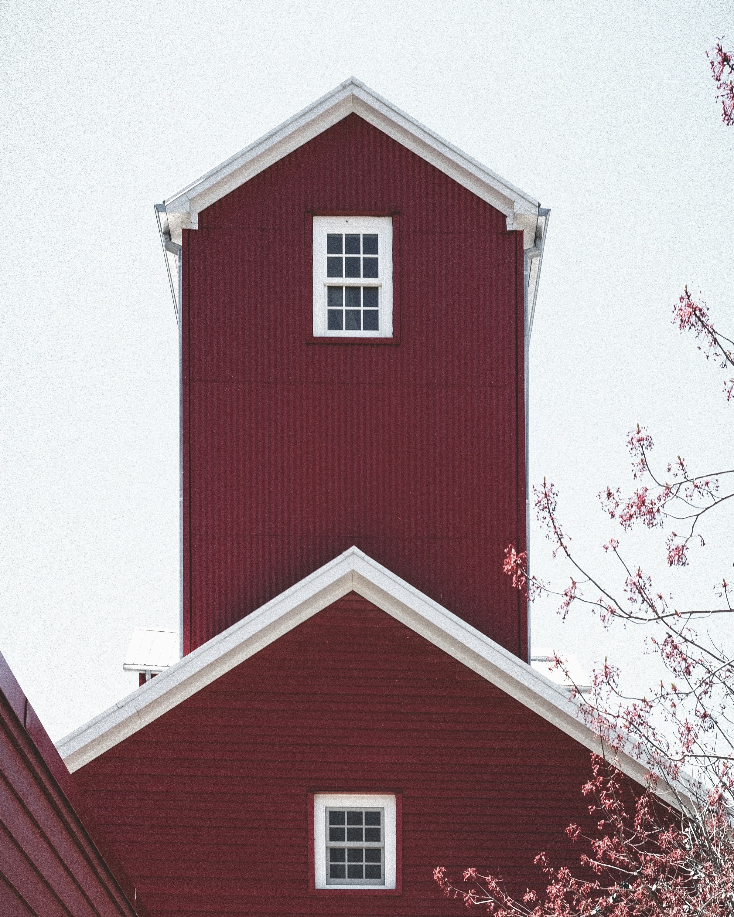 Symmetry in Scarlet: A Farm Tower Reaches Toward Winter Light