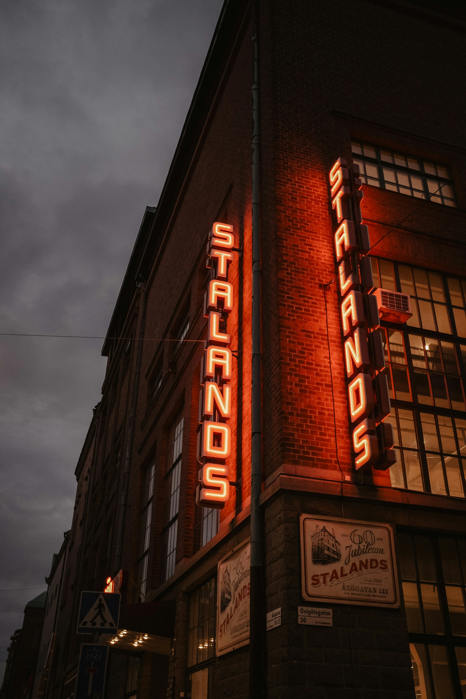 Neon Signage on a Brick Theater Façade at Dusk
