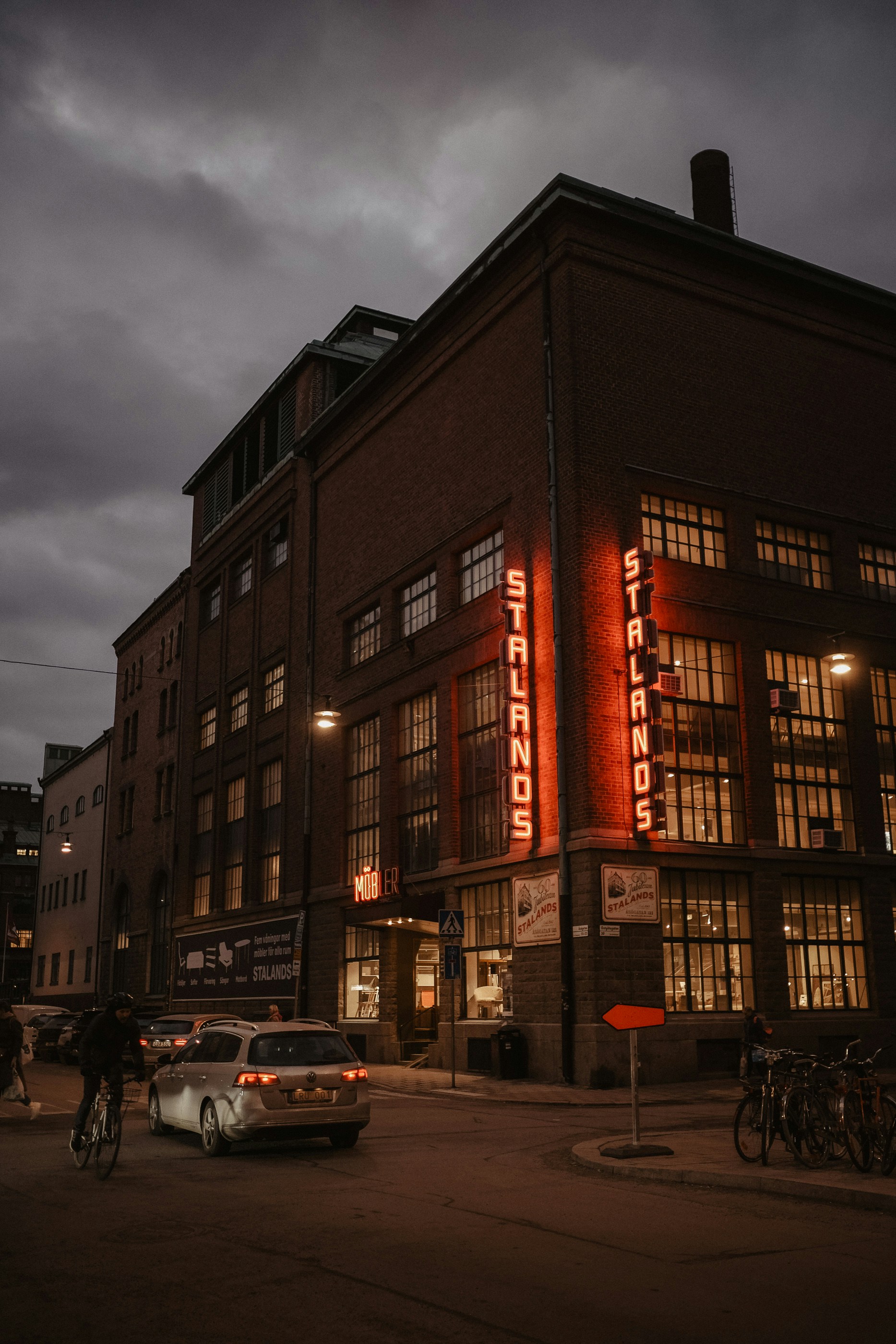 Crimson Neon on a Brick Corner at Dusk