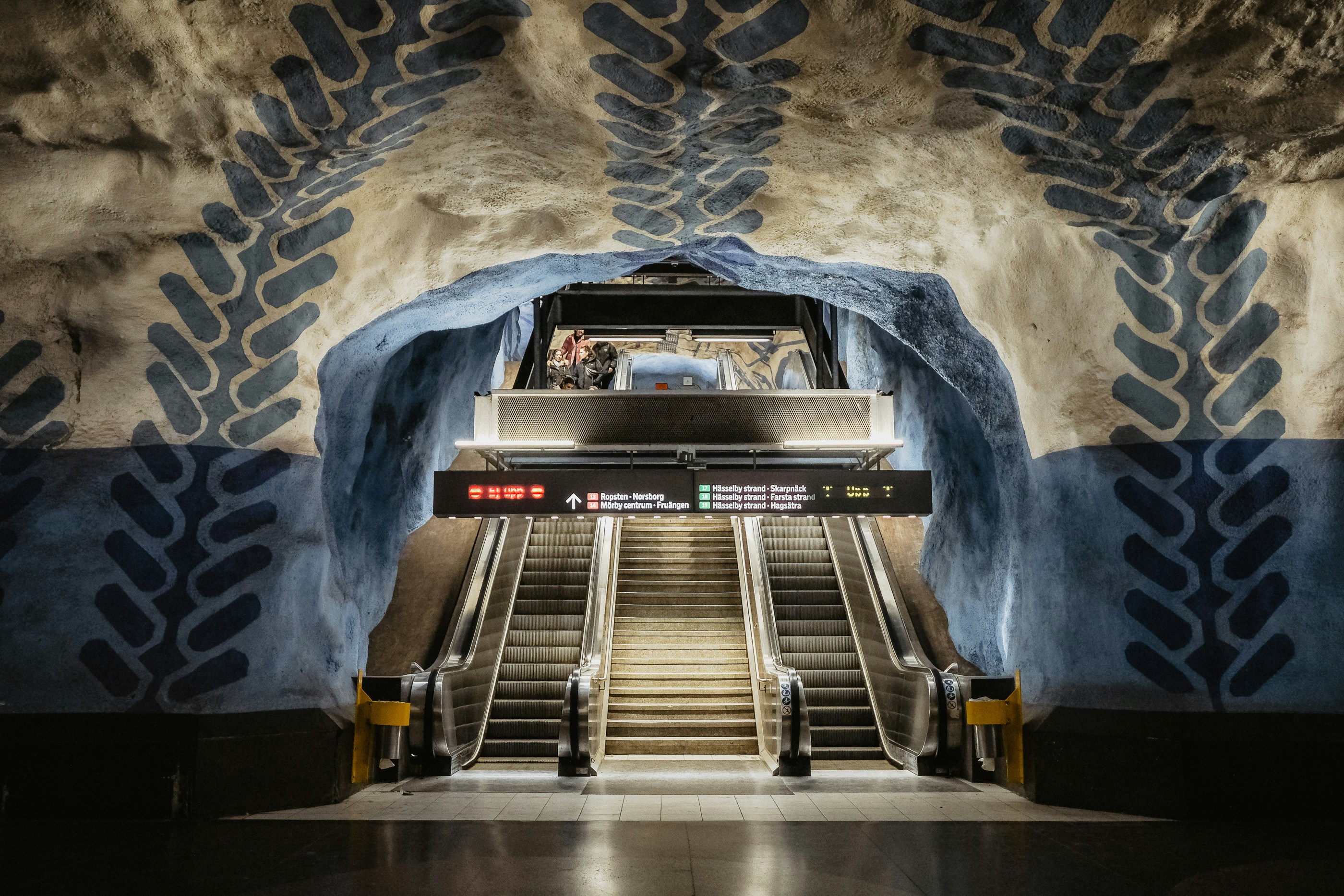 Echoes of the Ice Tunnel: Escalator Ascent Beneath Frosted Arches