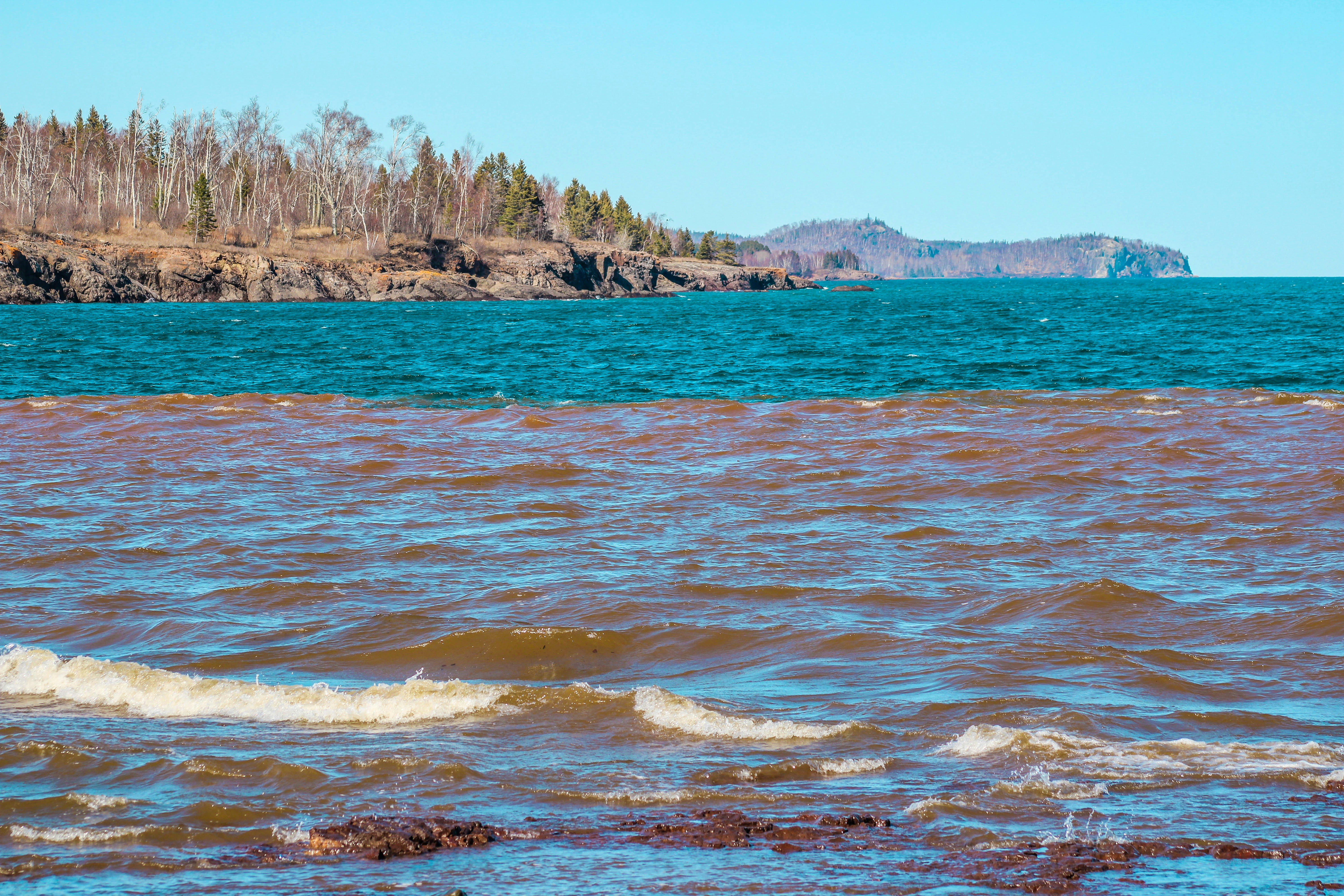 Tide in Two Tones: Brown Foreground Meets Blue Horizon