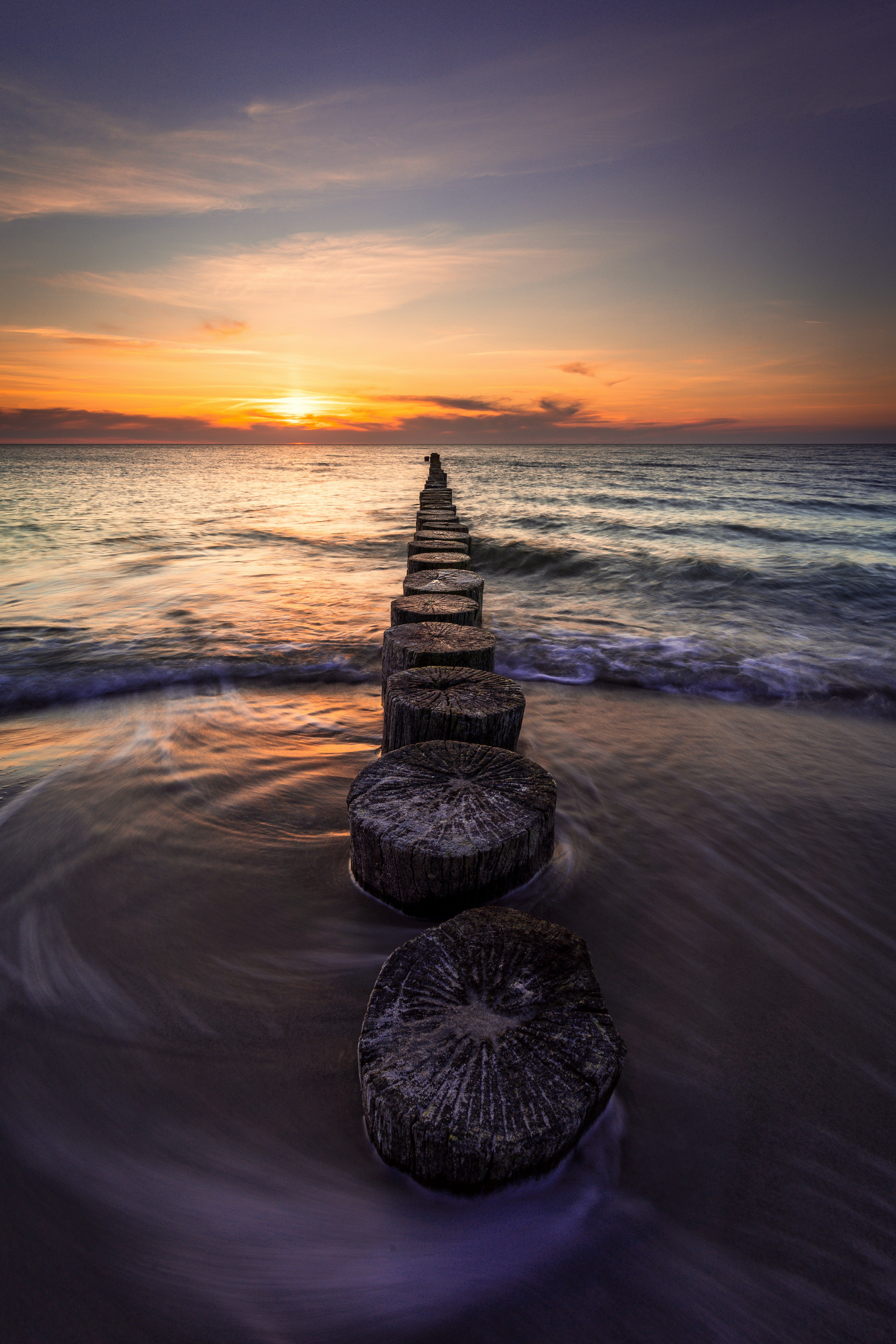Dusk on the Wooden Span: Weathered Posts Reaching Toward a Velvet Horizon