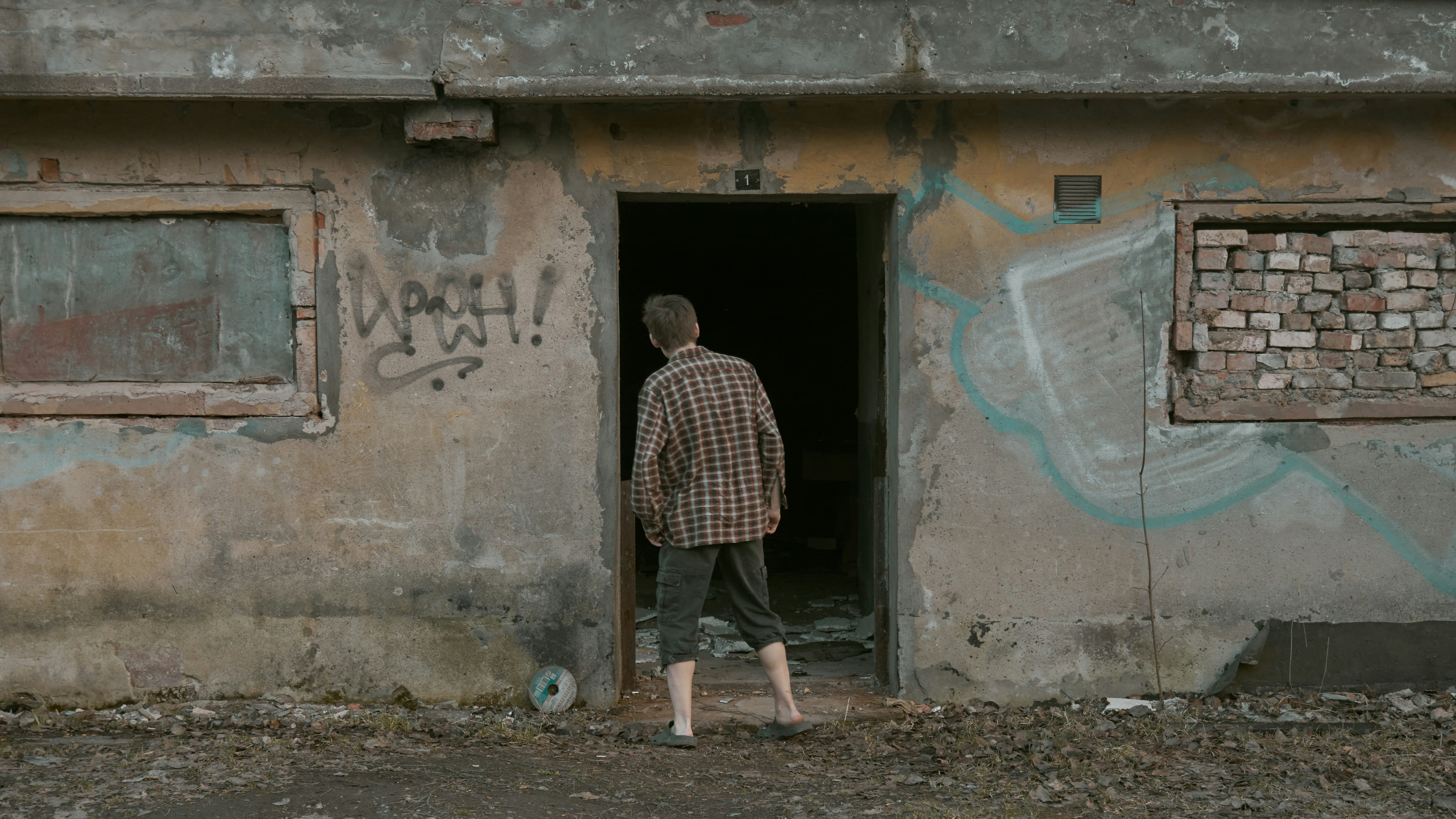 A person walking out of a building photo – Free Black Image on Unsplash