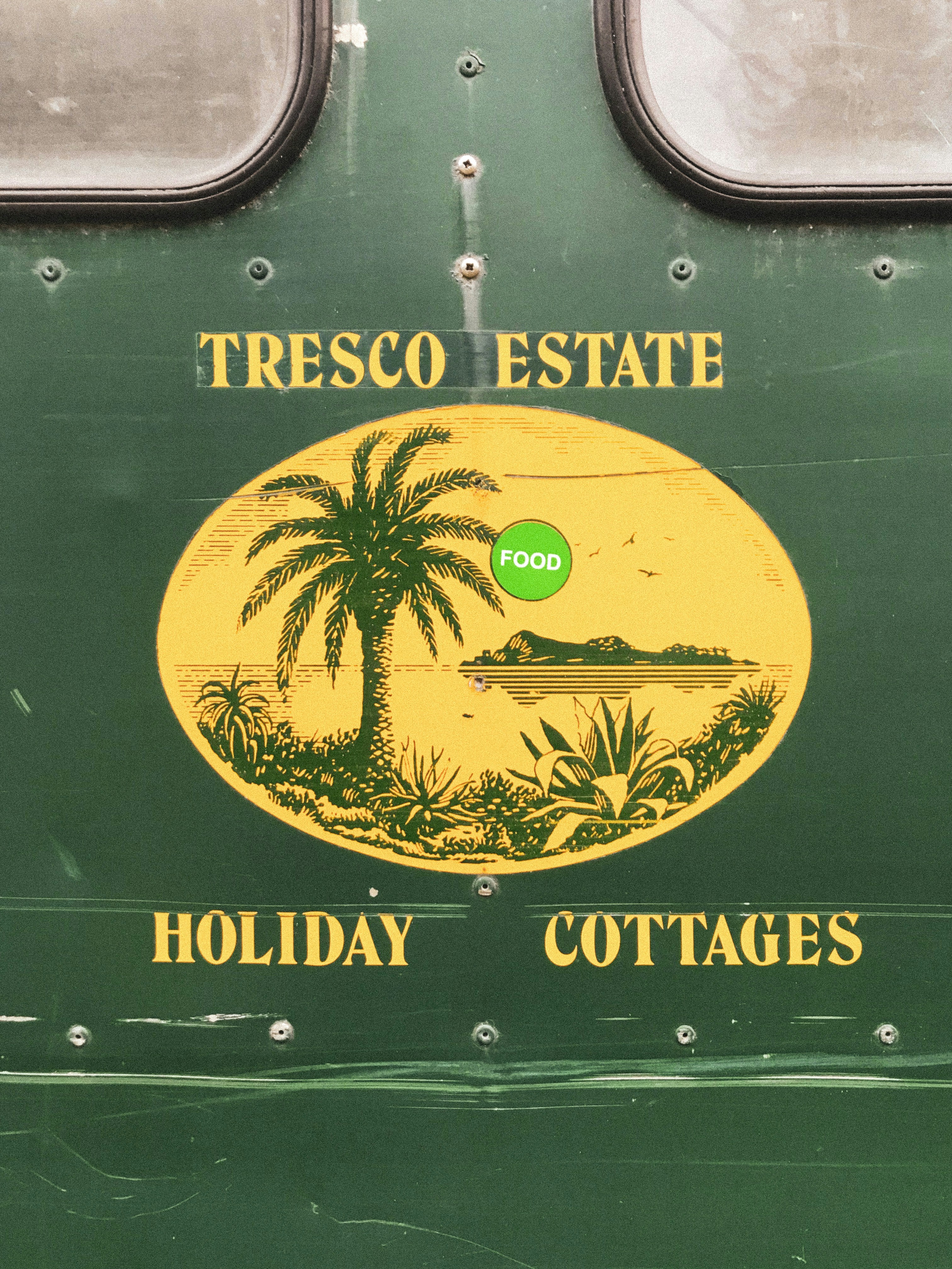 Tresco Estate Emblem: Palm and Island on a Weathered Green Panel