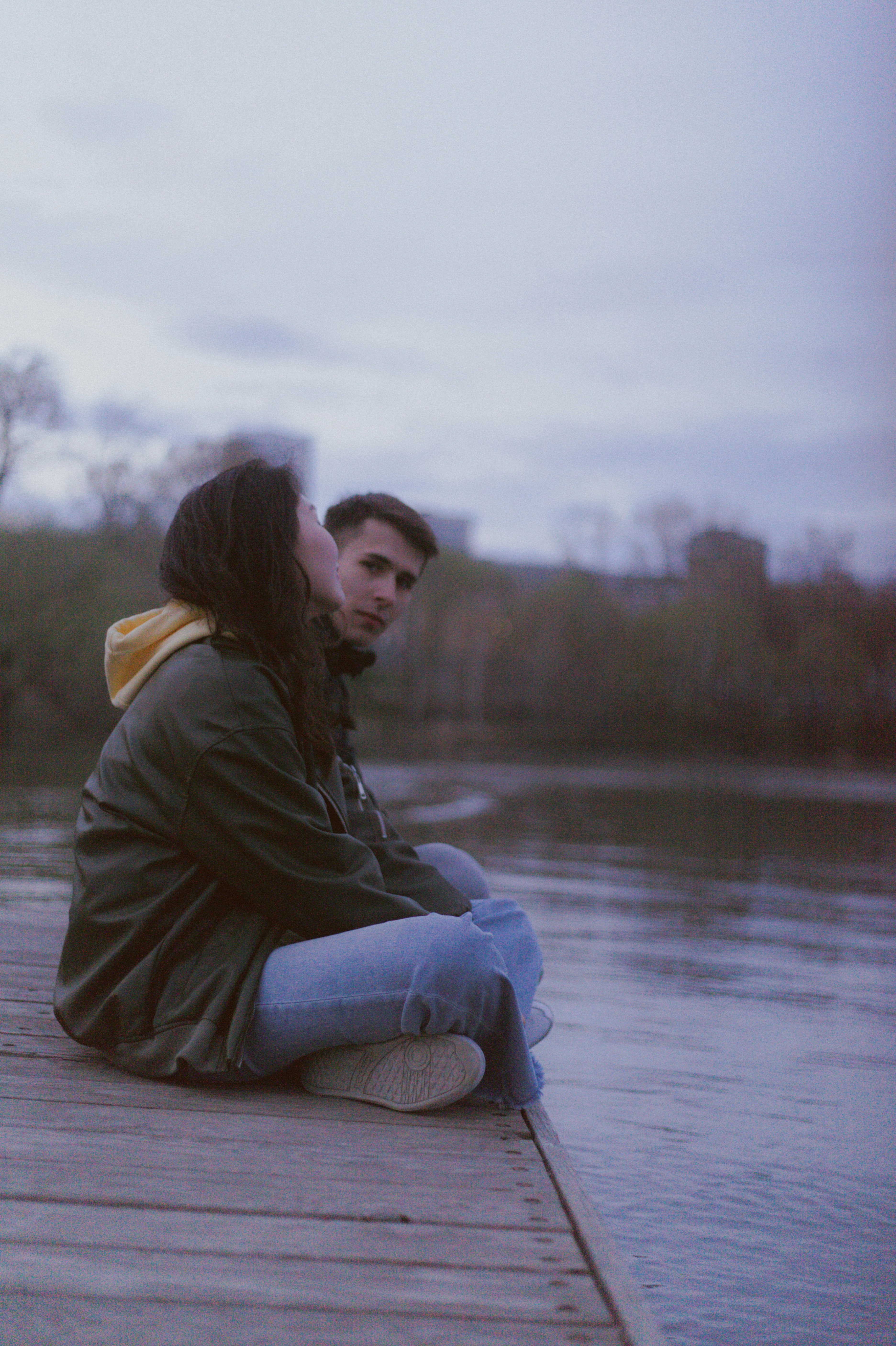 Photographer: anastasiavityukova__ (inst) | a man and woman sitting on a dock by a lake