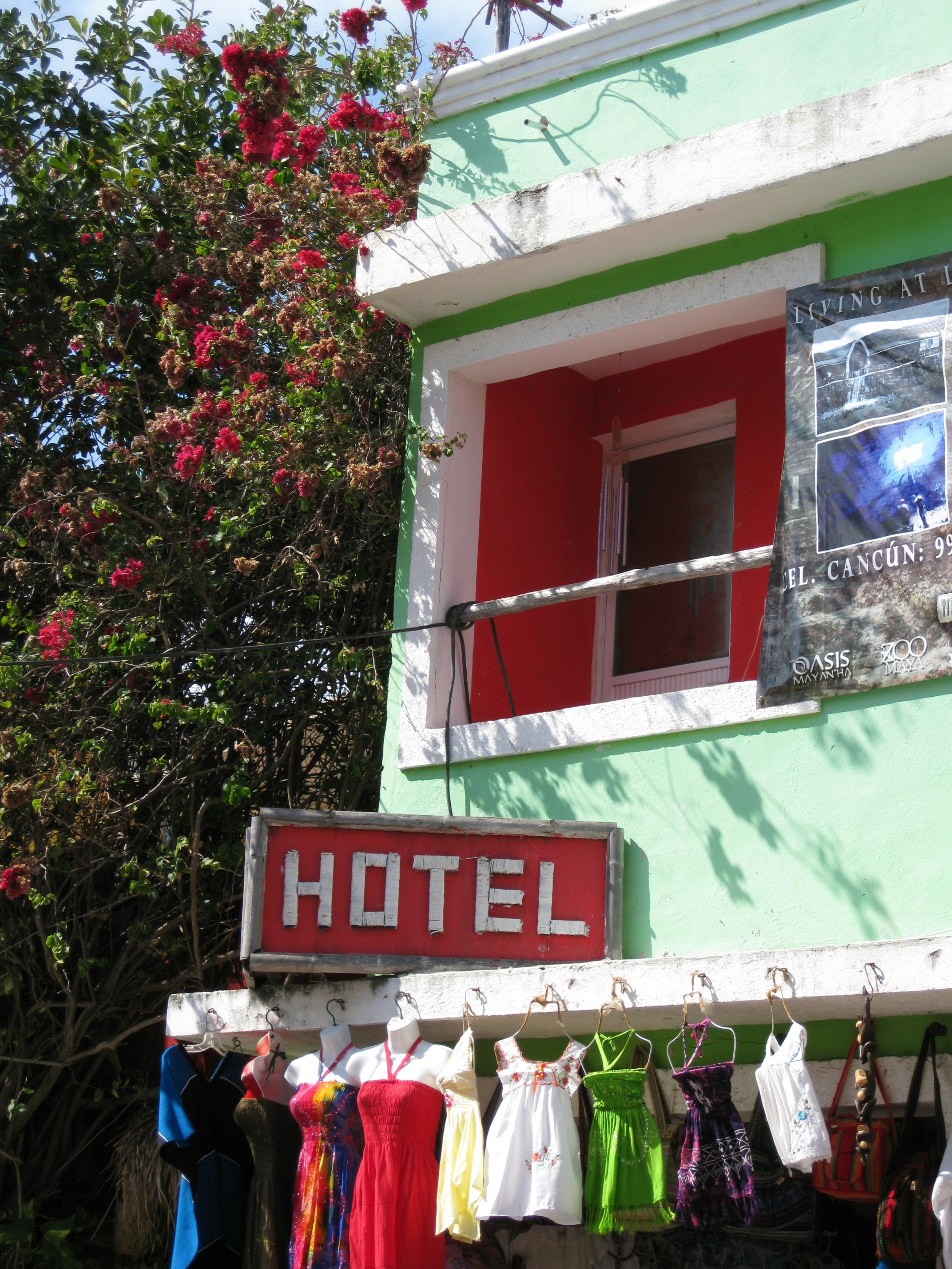 Colorful Beachfront Hotel Facade with Hanging Dresses