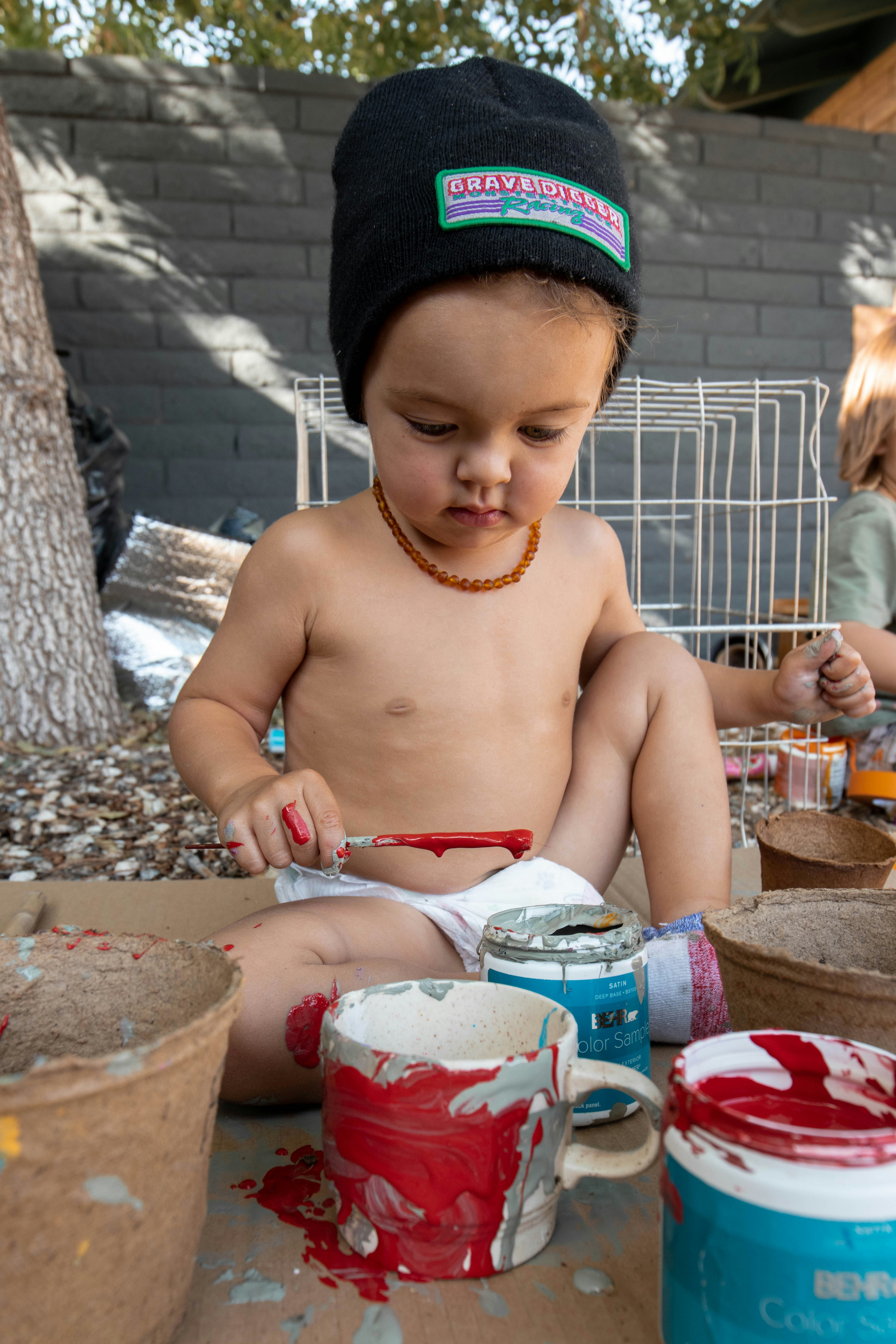 Tiny Hands, Bold Reds: A Backyard Paint Session