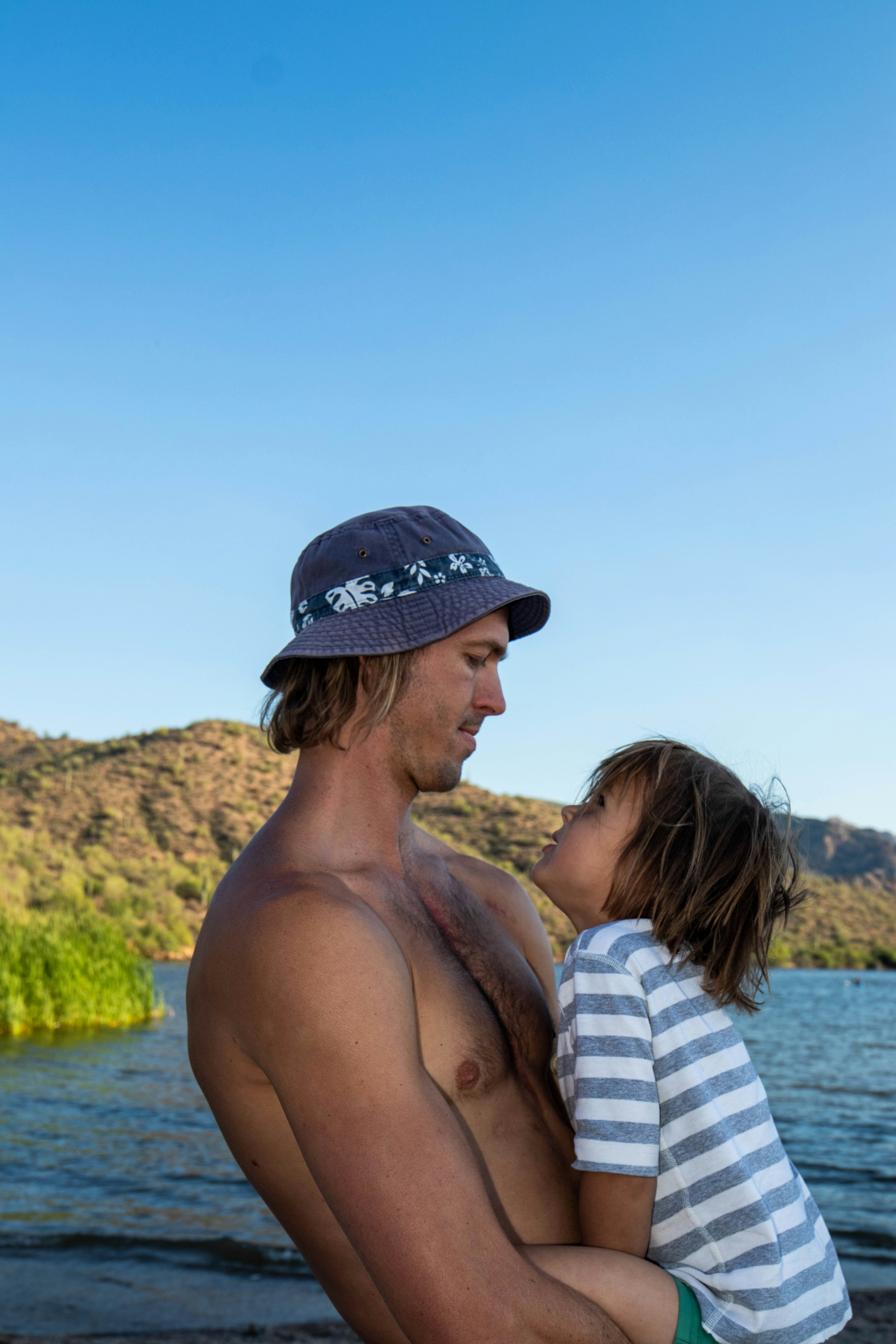 Lakeside Reverie: A father’s quiet embrace by sunlit water