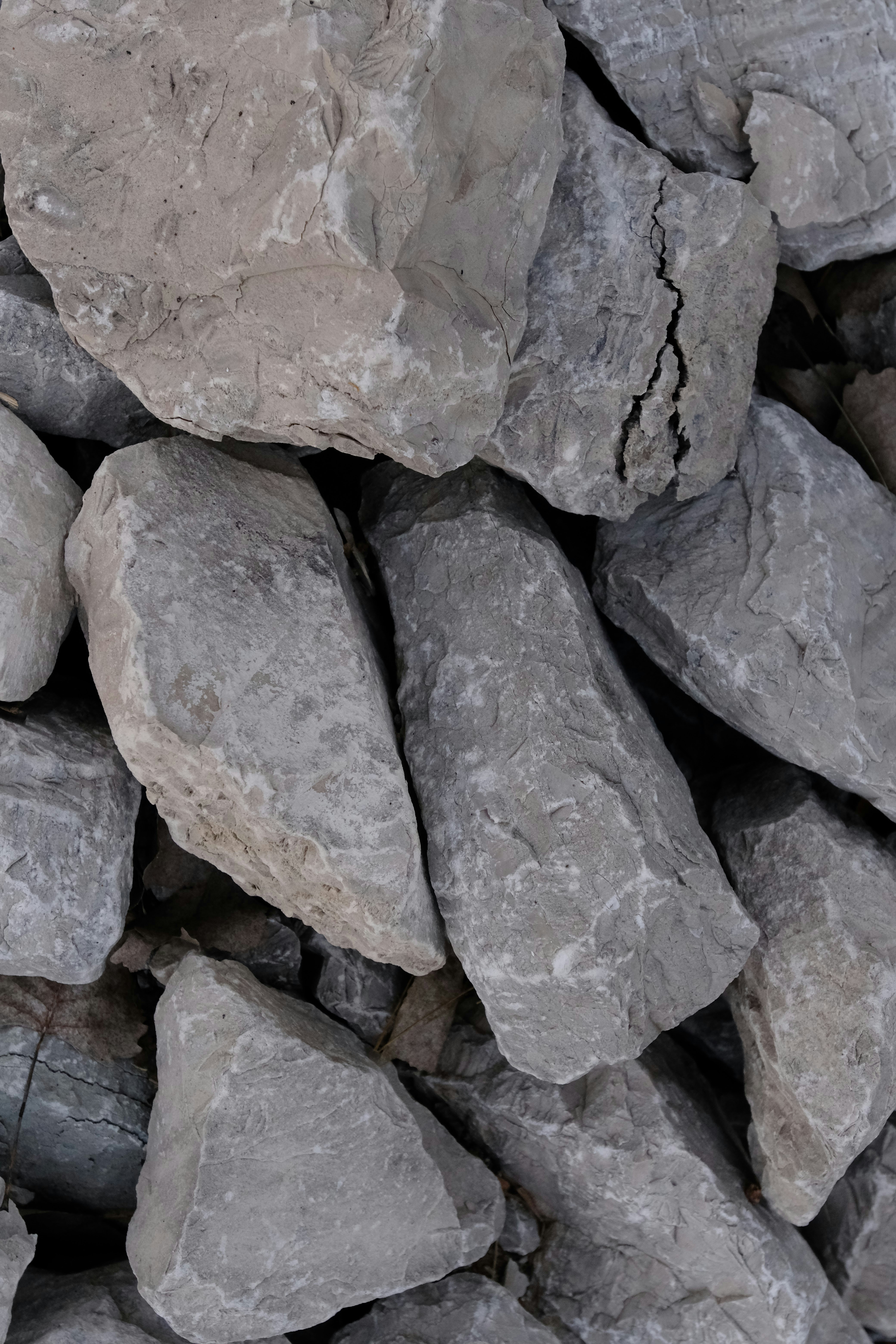 A textured arrangement of gray rocks, showcasing various shapes and surfaces in a natural setting.