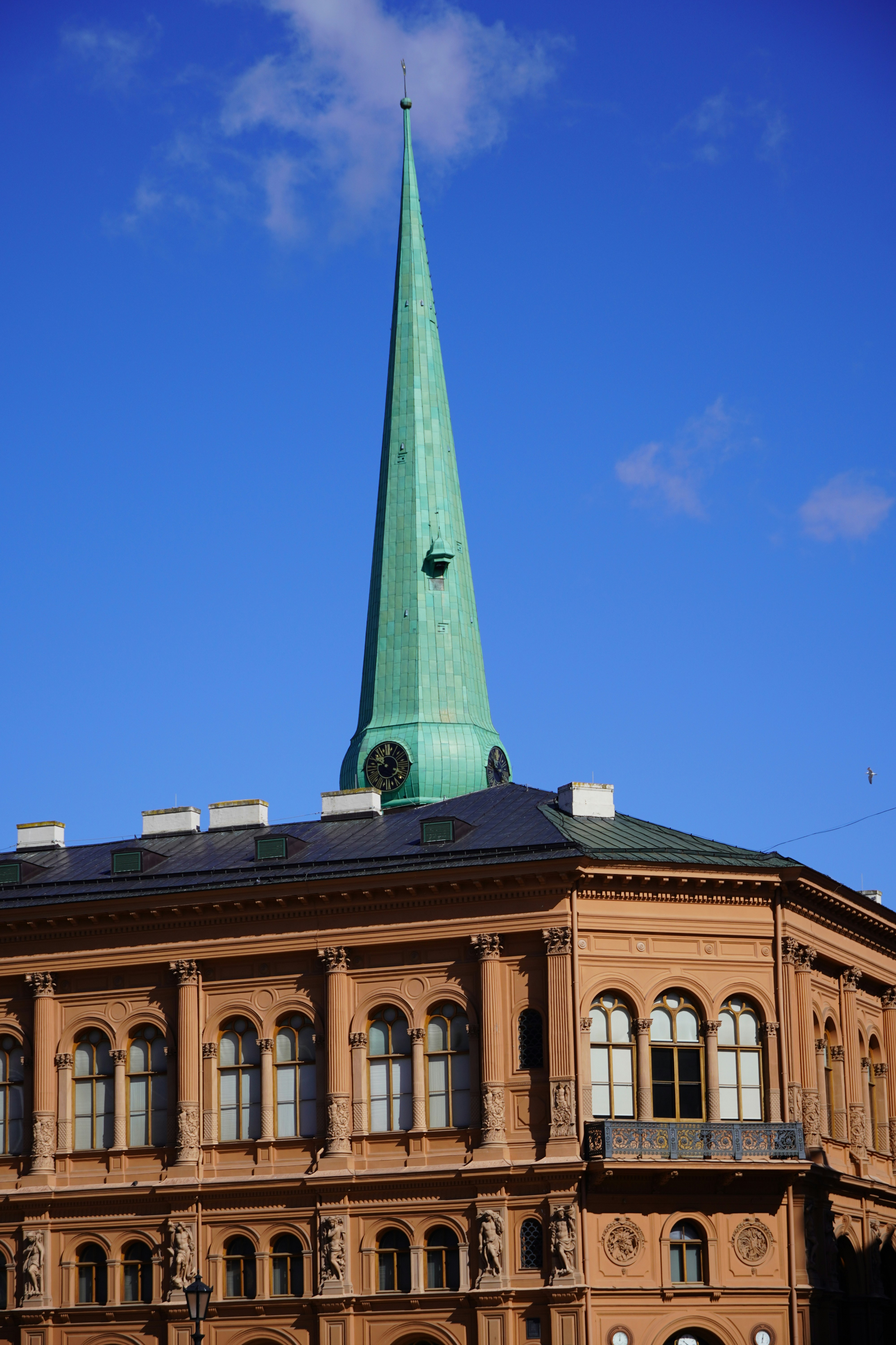 A tall building with a green steeple photo – Free Riga Image on Unsplash