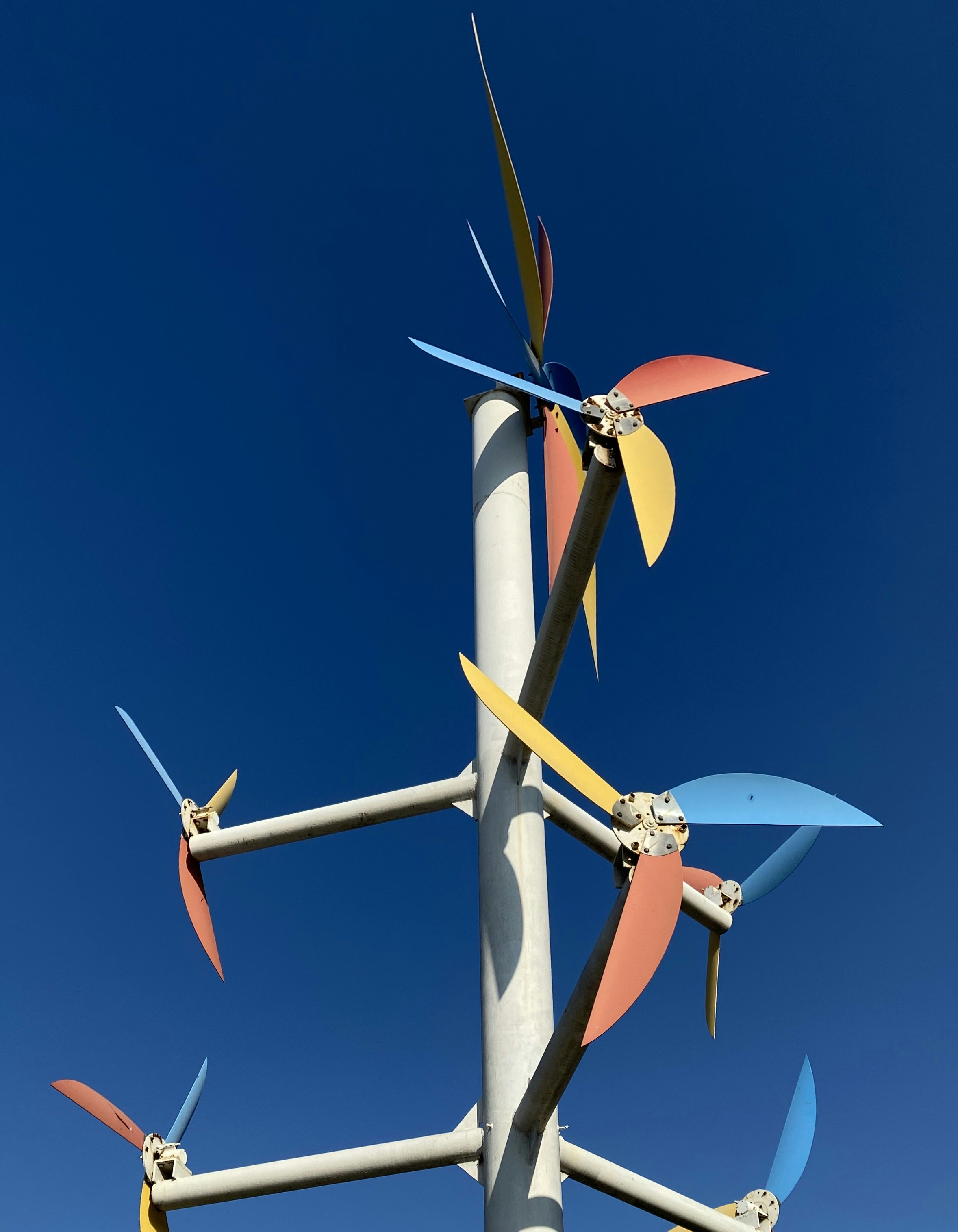 Chromatic Wind-Tree: A Vertical Sculpture of Colorful Blades Reaching the Sky