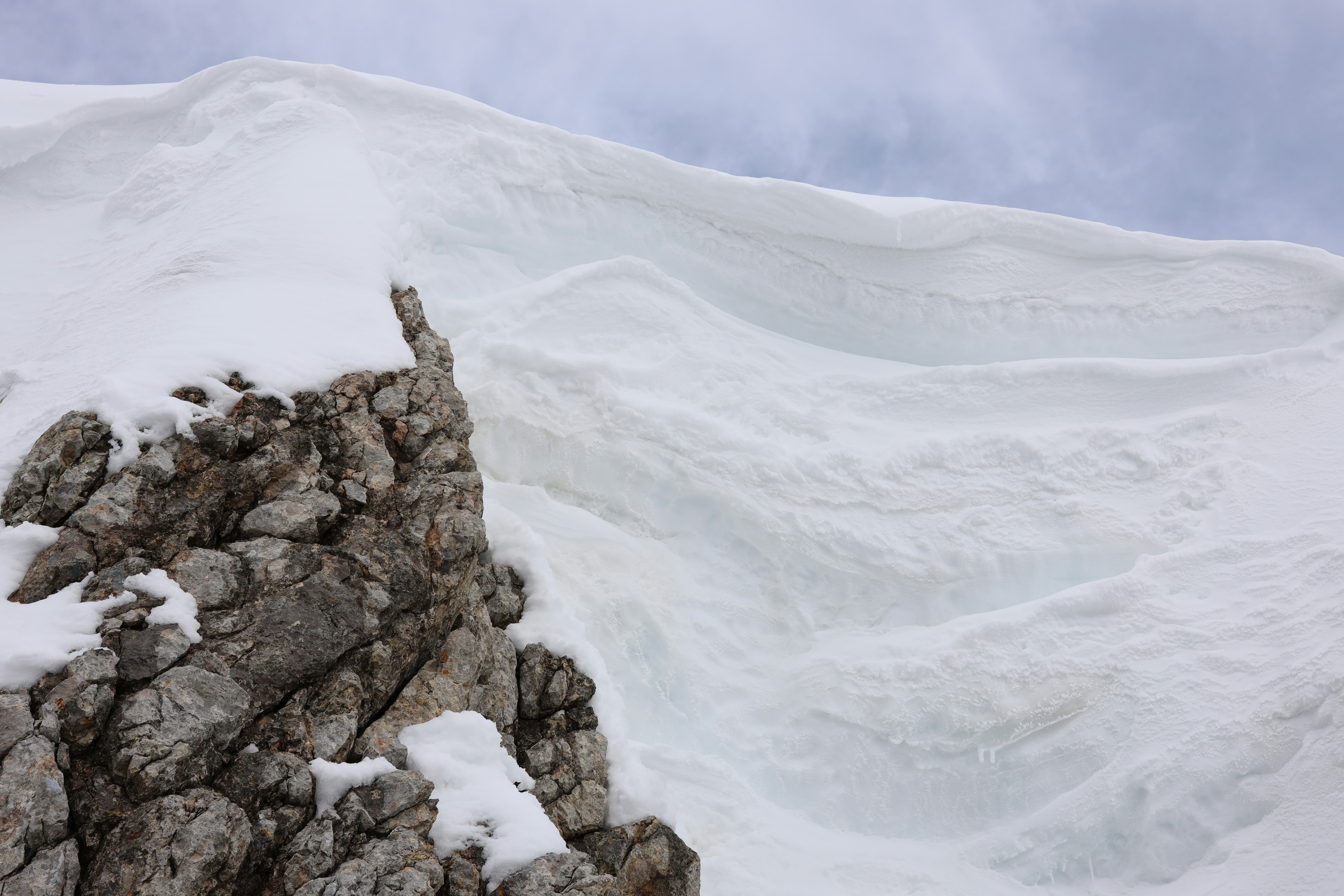 A snowy mountain with rocks photo – Free Mountain Image on Unsplash
