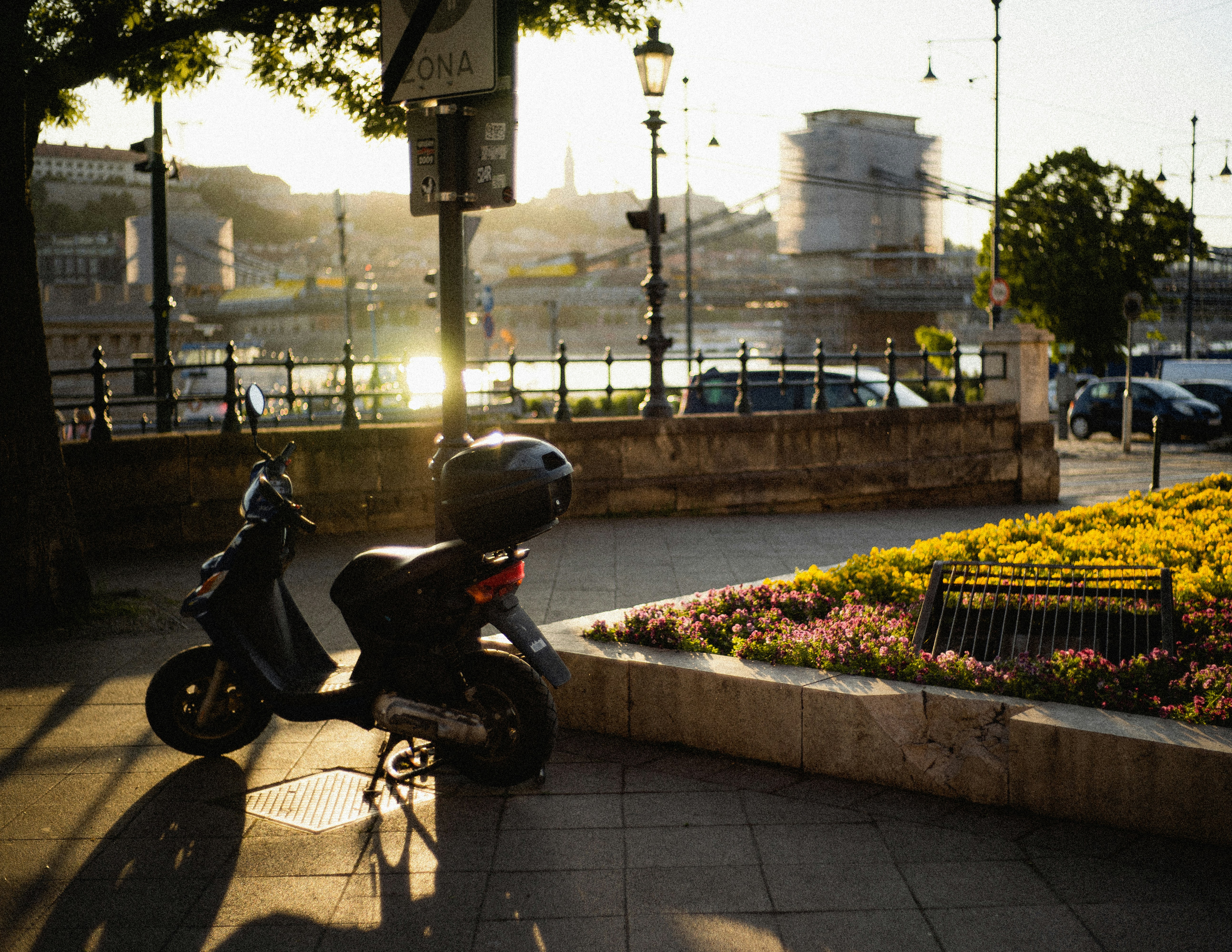 Dockside Vespa in Golden Hour: Shadows and Reflections by the River