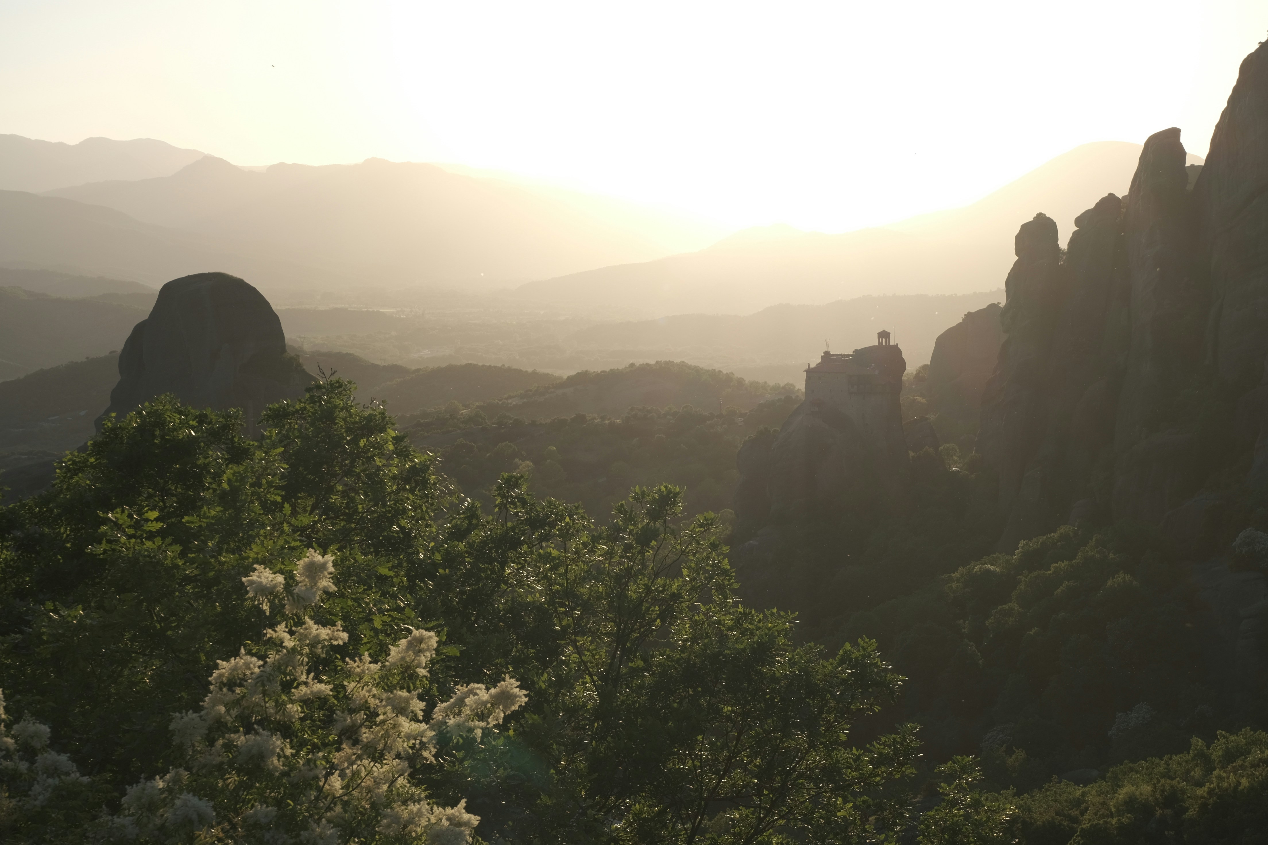 Dawn Sentinel: A lone figure crowns a rocky promontory