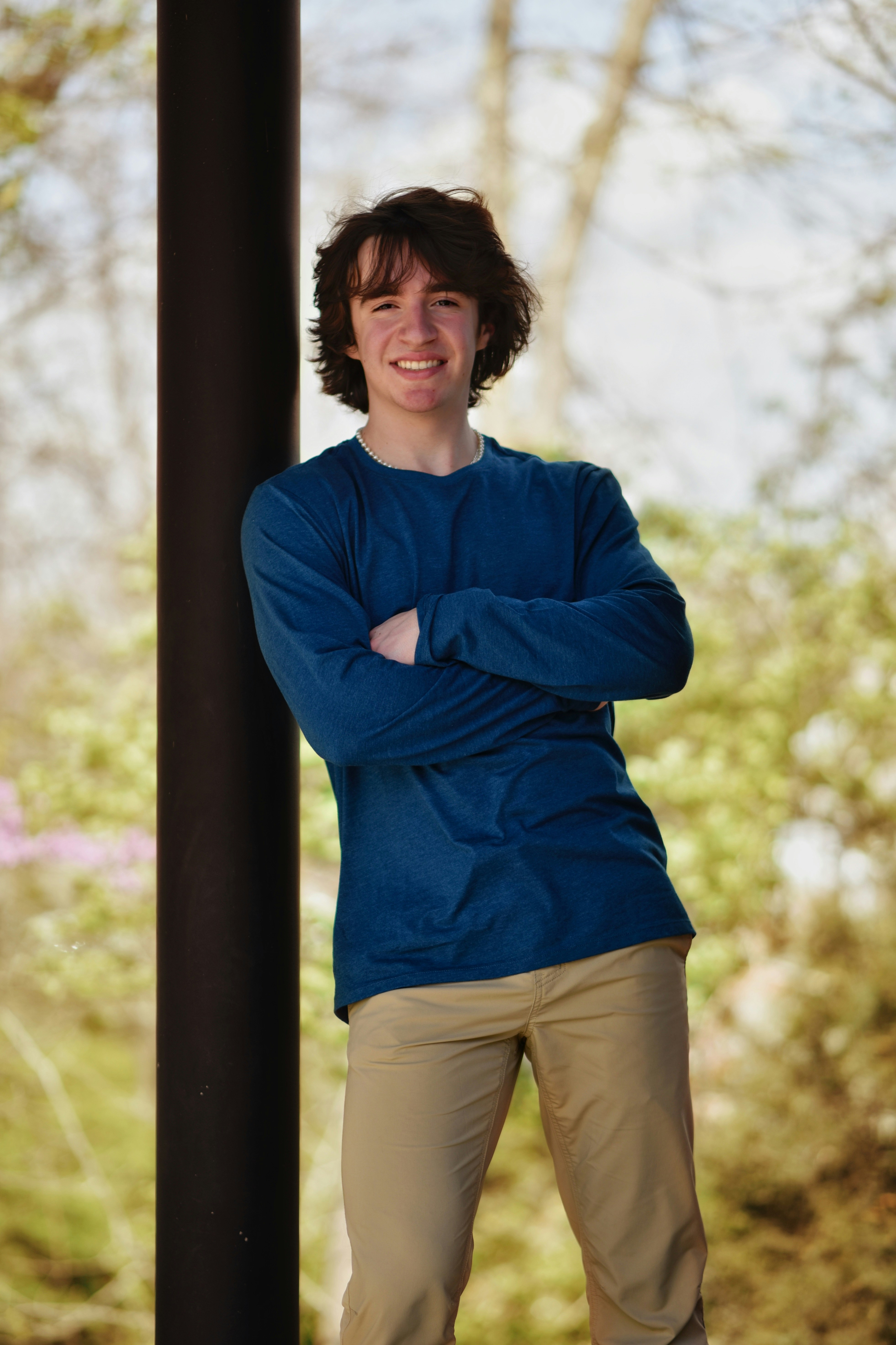 A person standing by a pole photo – Free Portrait Image on Unsplash