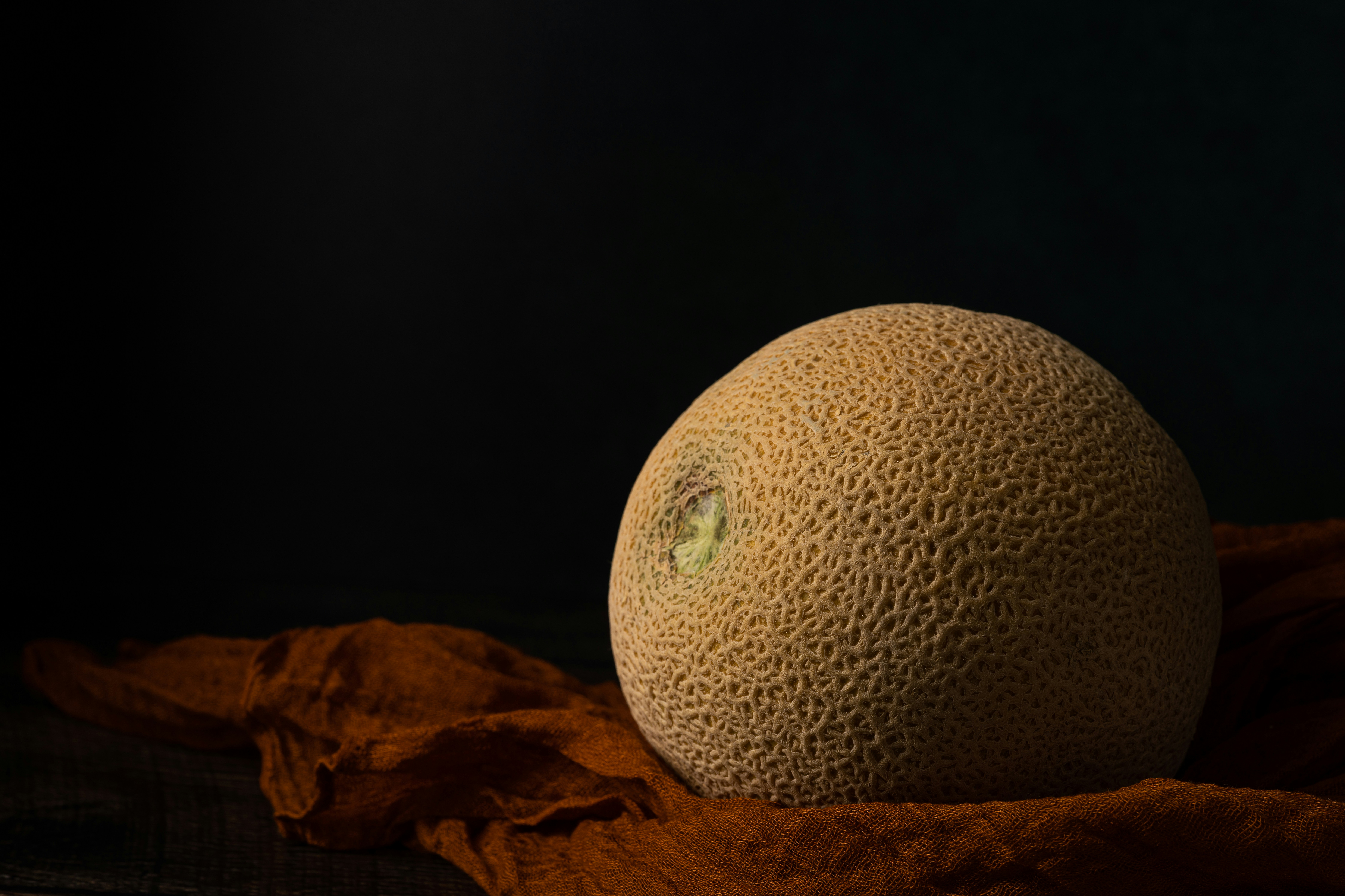 Amber Orb on Velvet Rust: A Quiet Study of Texture