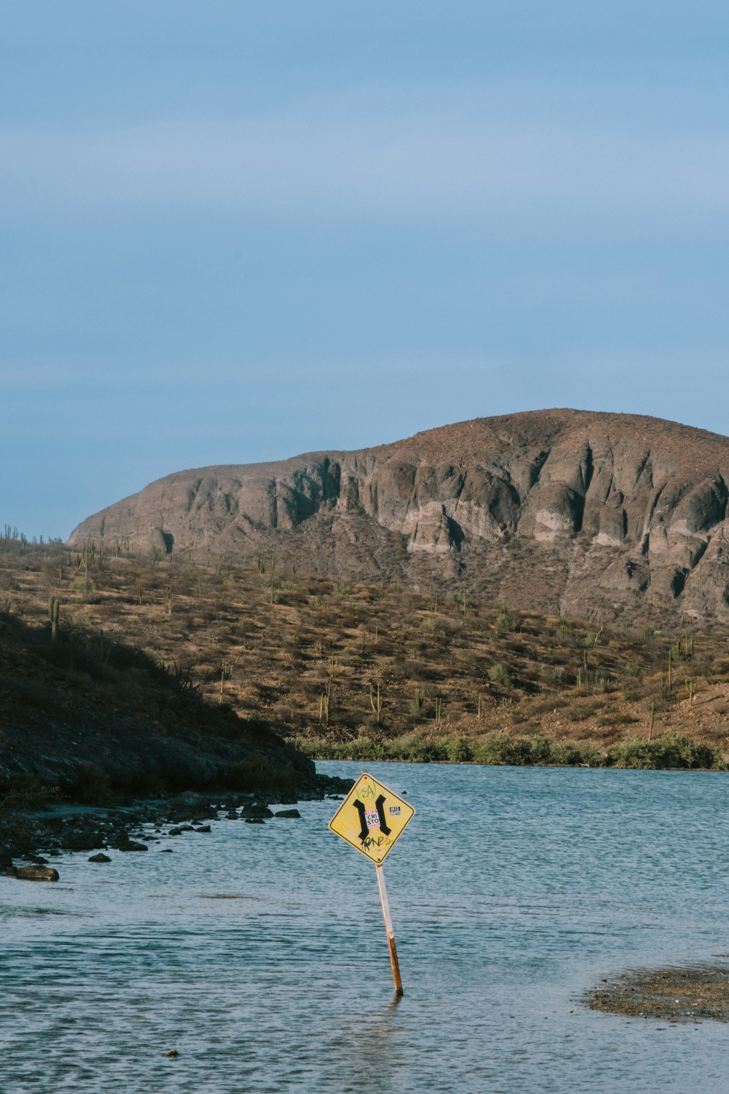 A yellow sign in the water photo – Free Water Image on Unsplash